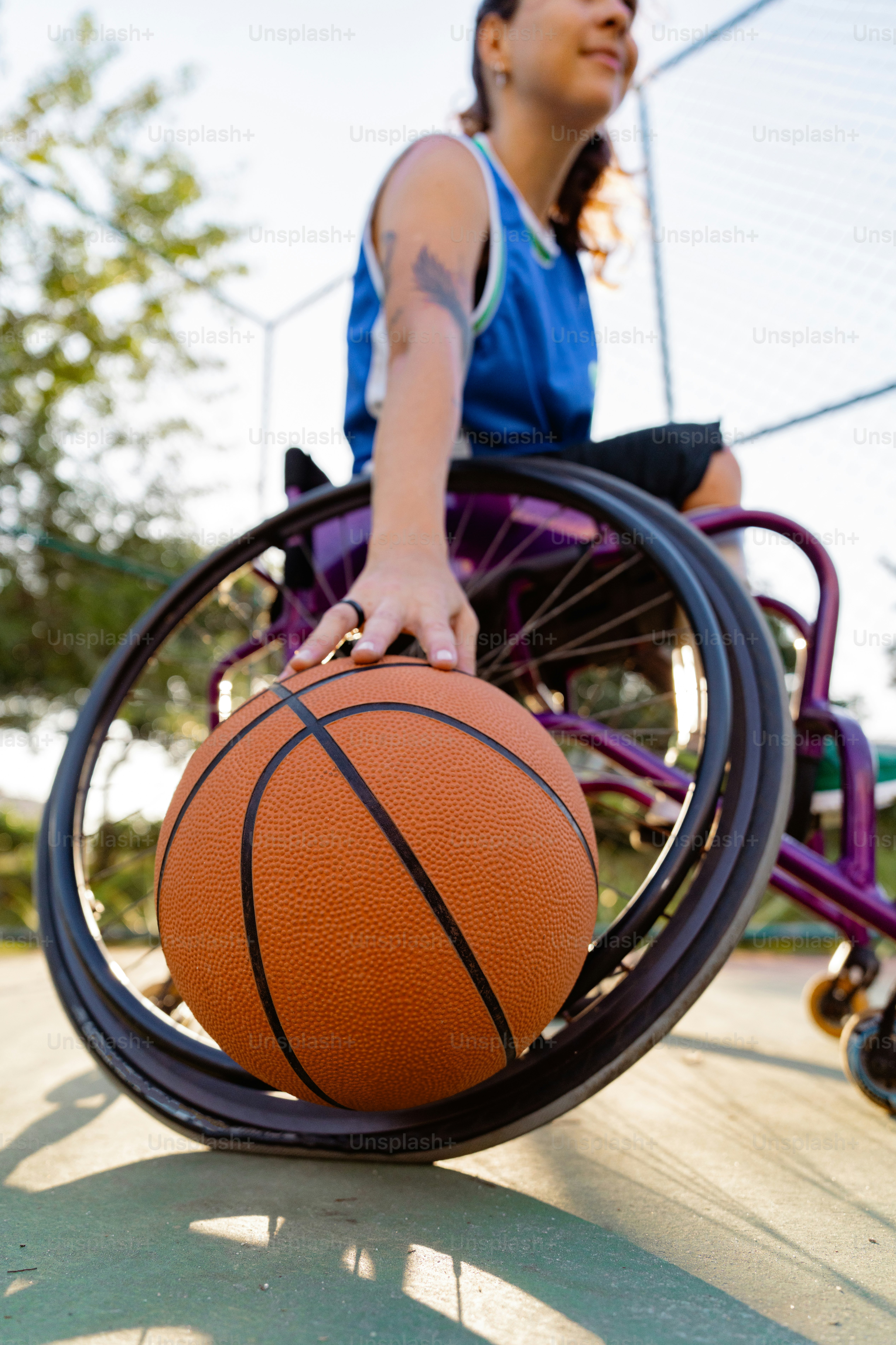 A woman in a wheel chair holding a basketball photo – Basketball Image ...