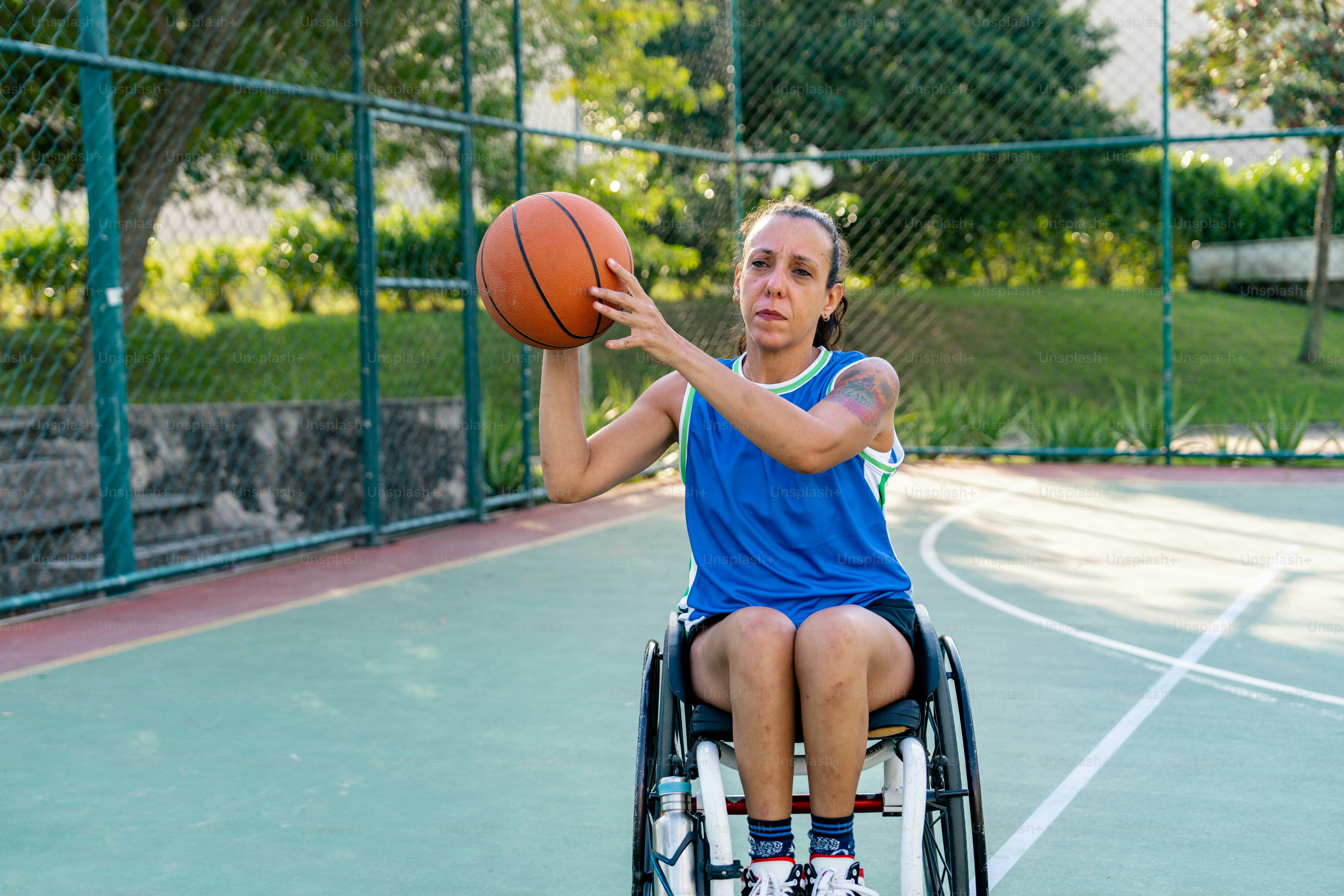 A woman in a wheel chair holding a basketball photo – Basketball Image ...