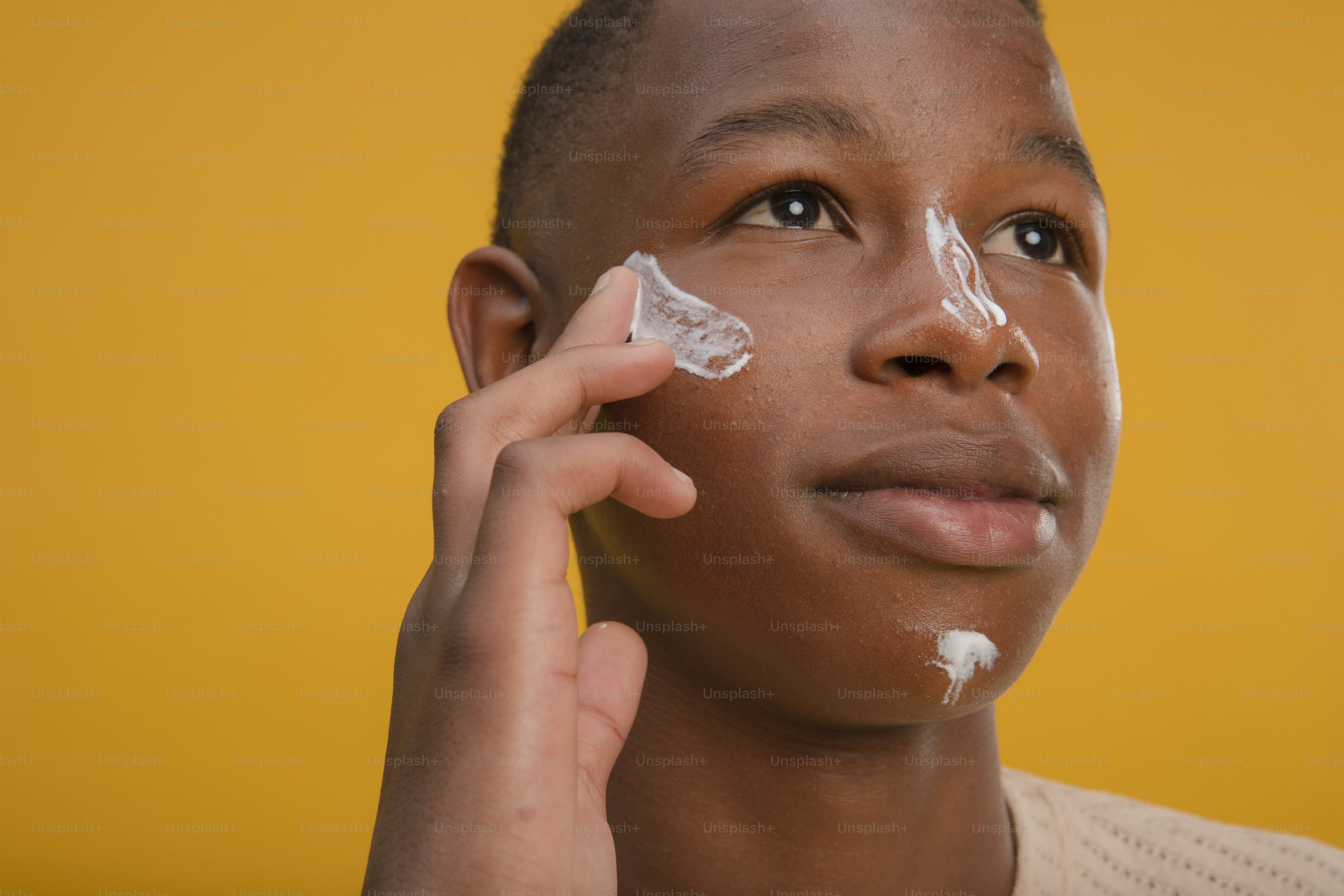 A young boy with a white mask on his face photo – Health Image on Unsplash