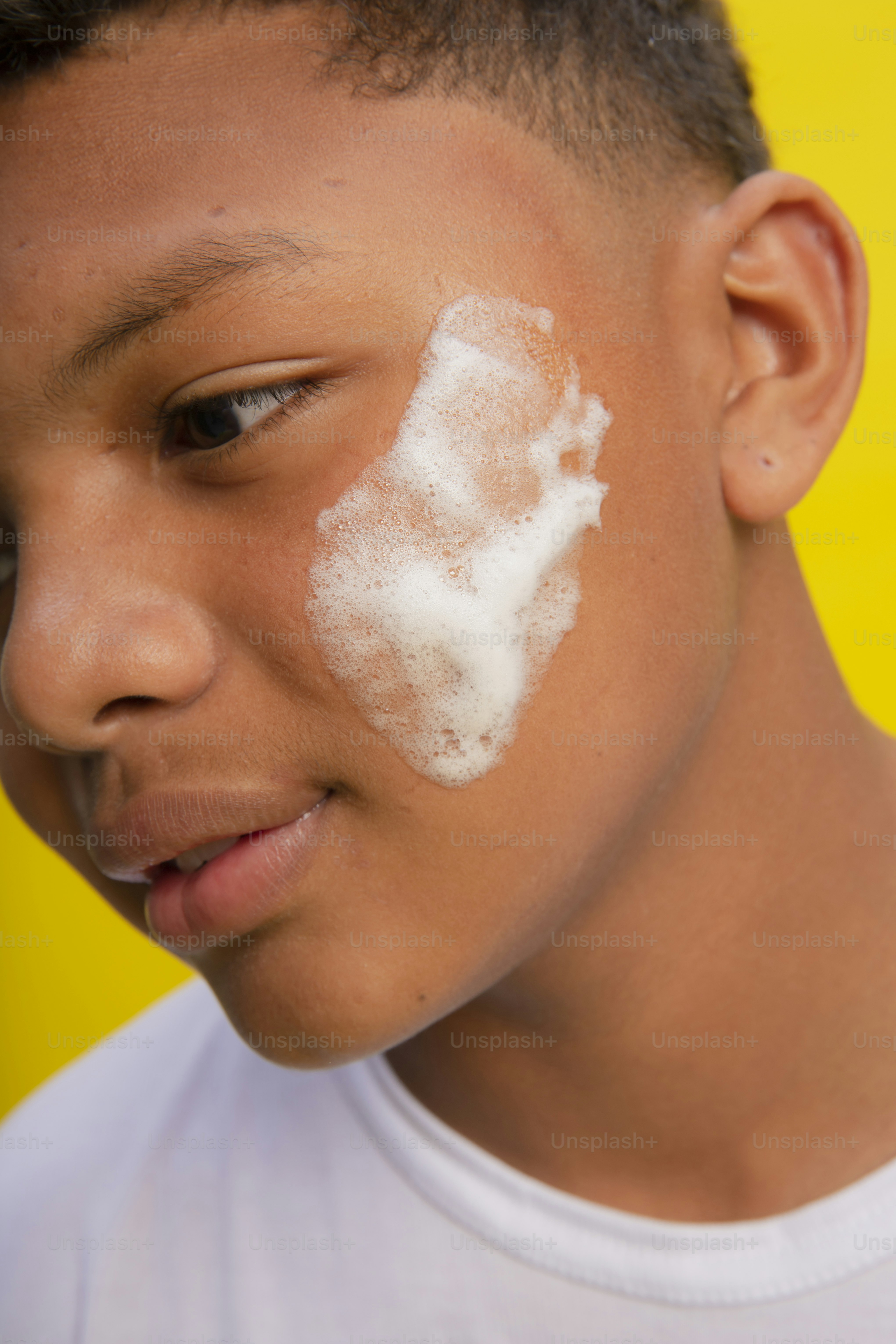 A young boy with white powder on his face photo – Skincare routine ...
