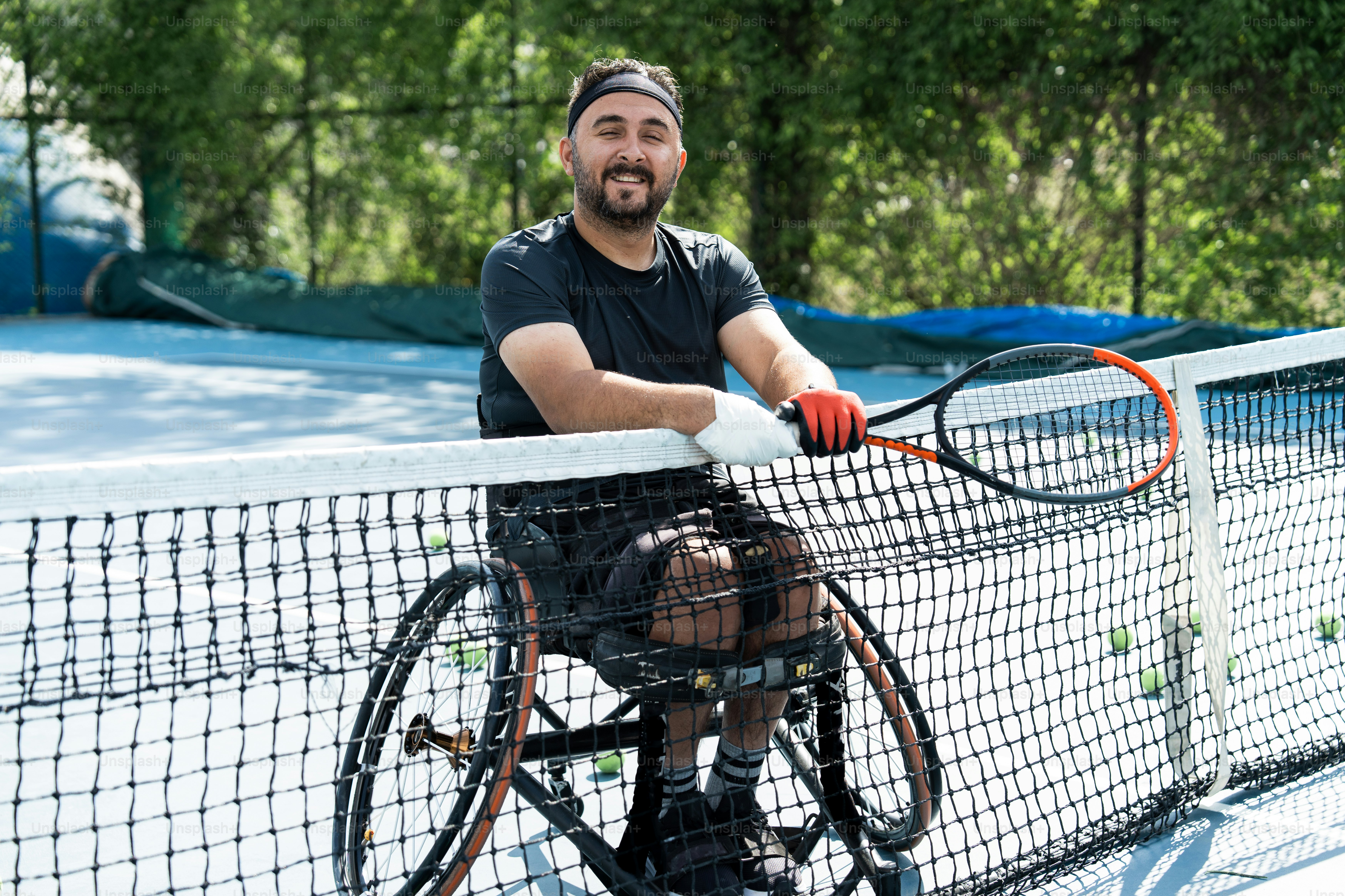 A man in a wheel chair holding a tennis racket photo – Olympic sport ...
