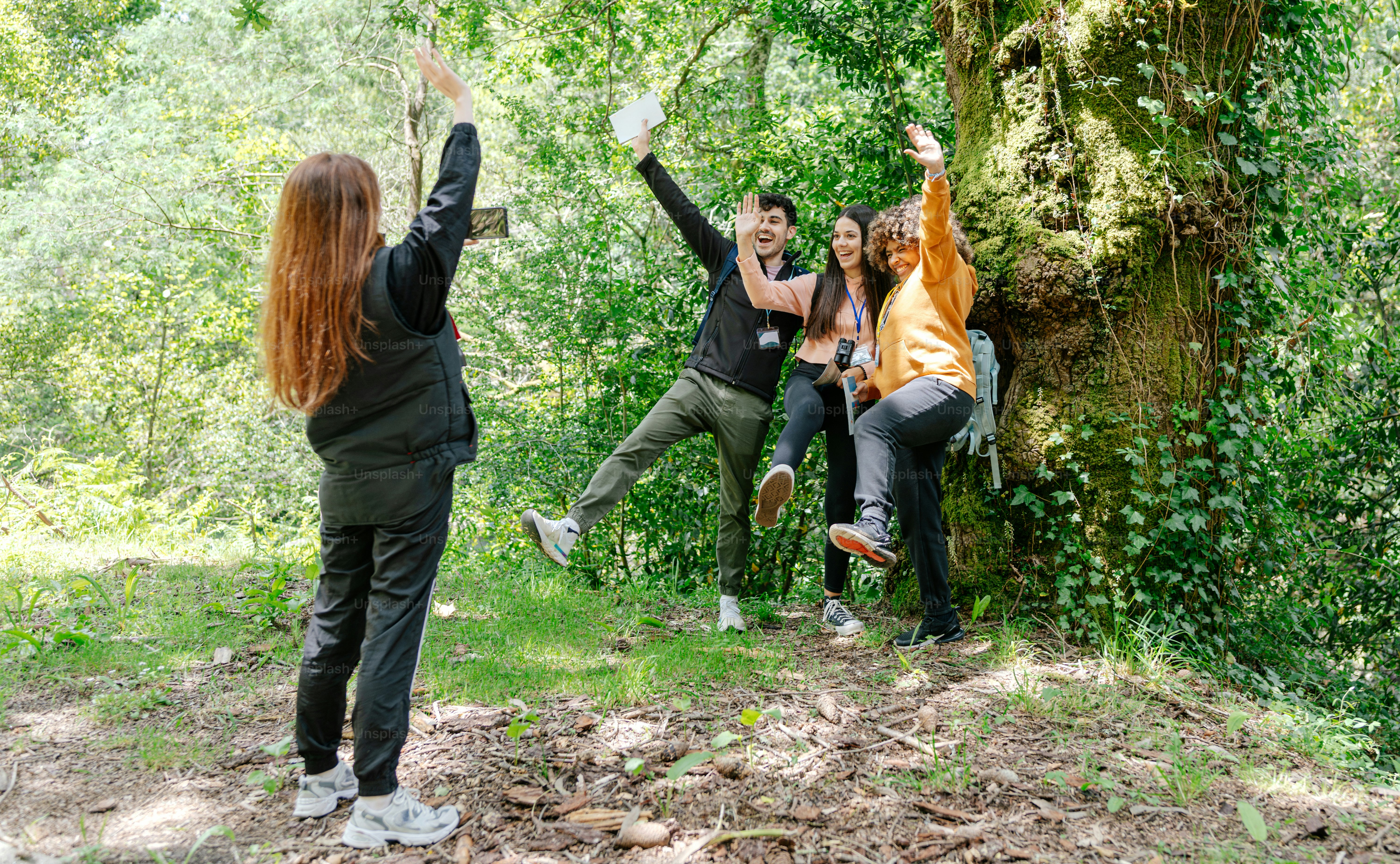 A group of people standing around a map photo – Group travel Image on ...