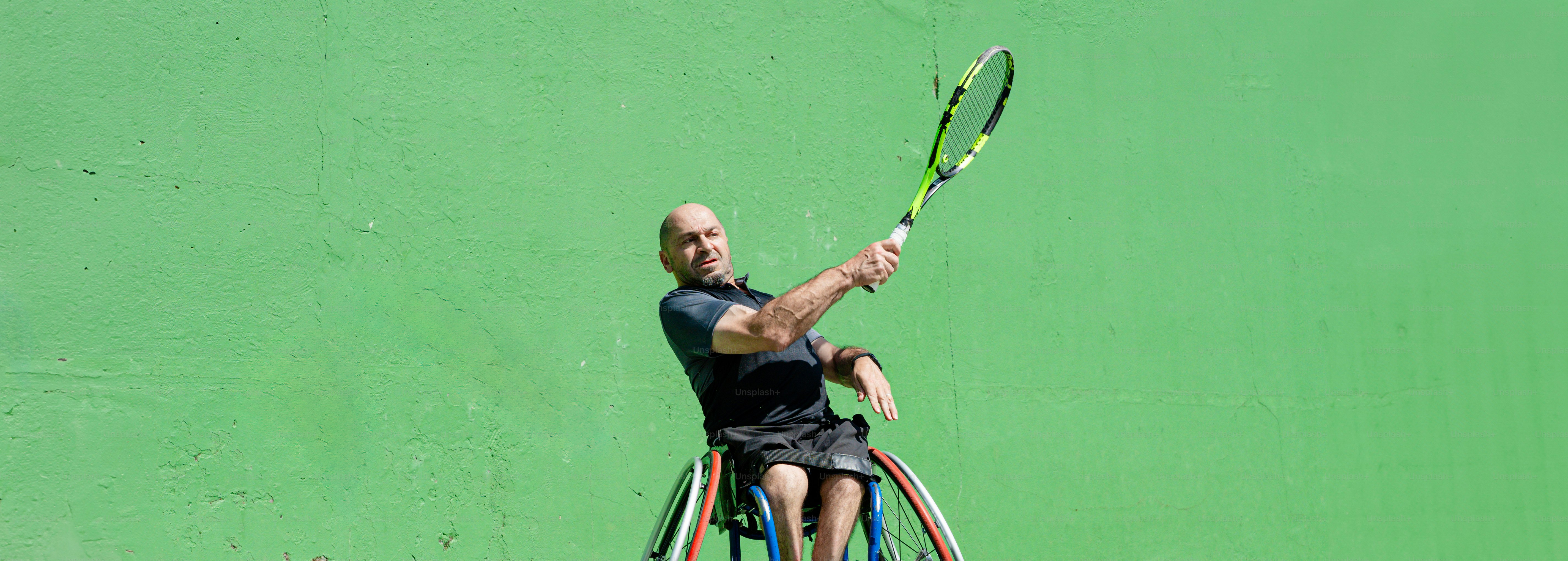 A man in a wheelchair holding a tennis racket photo – Sport Image on ...
