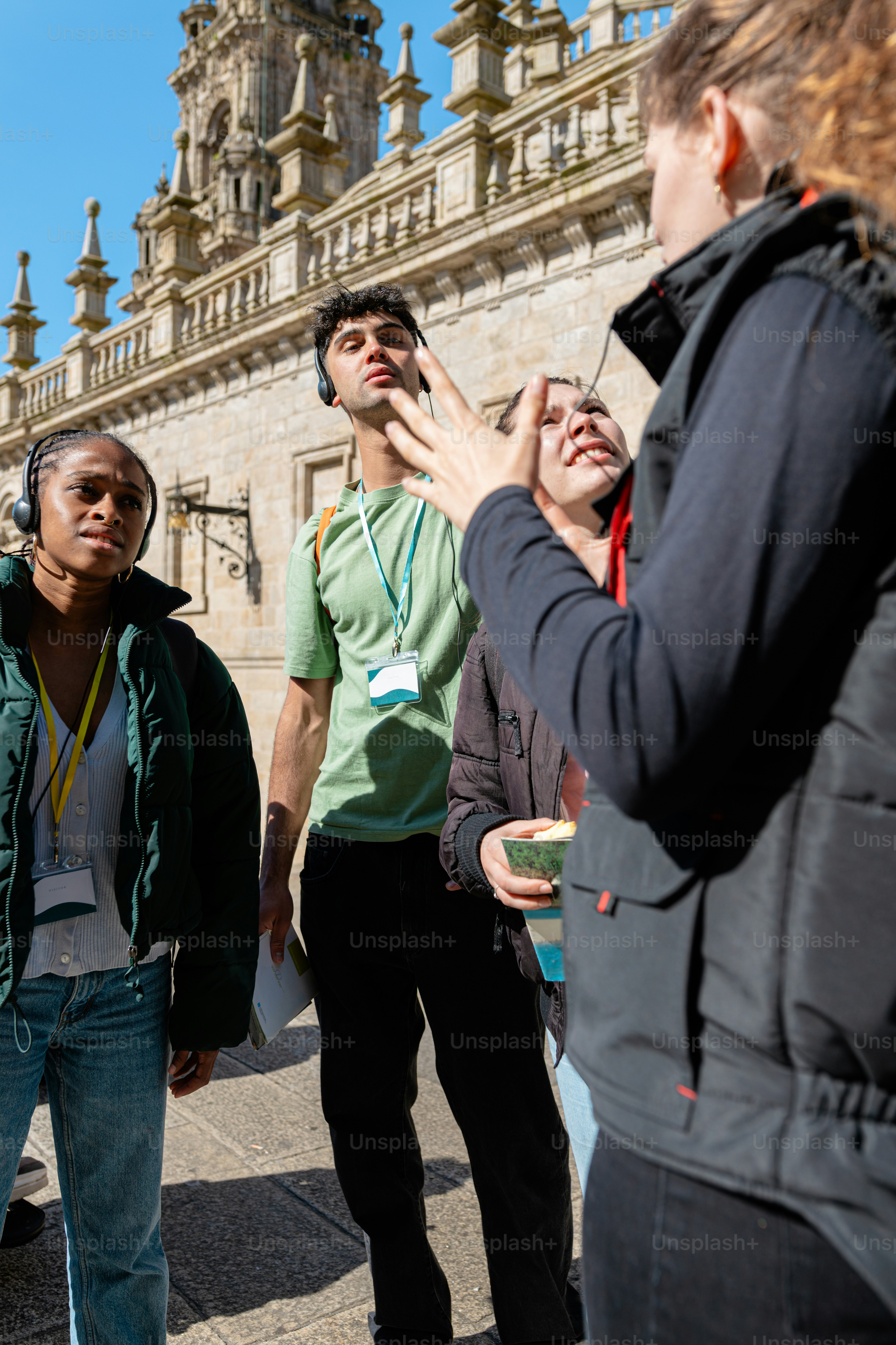 A group of people standing around each other photo – Sightseeing Image ...