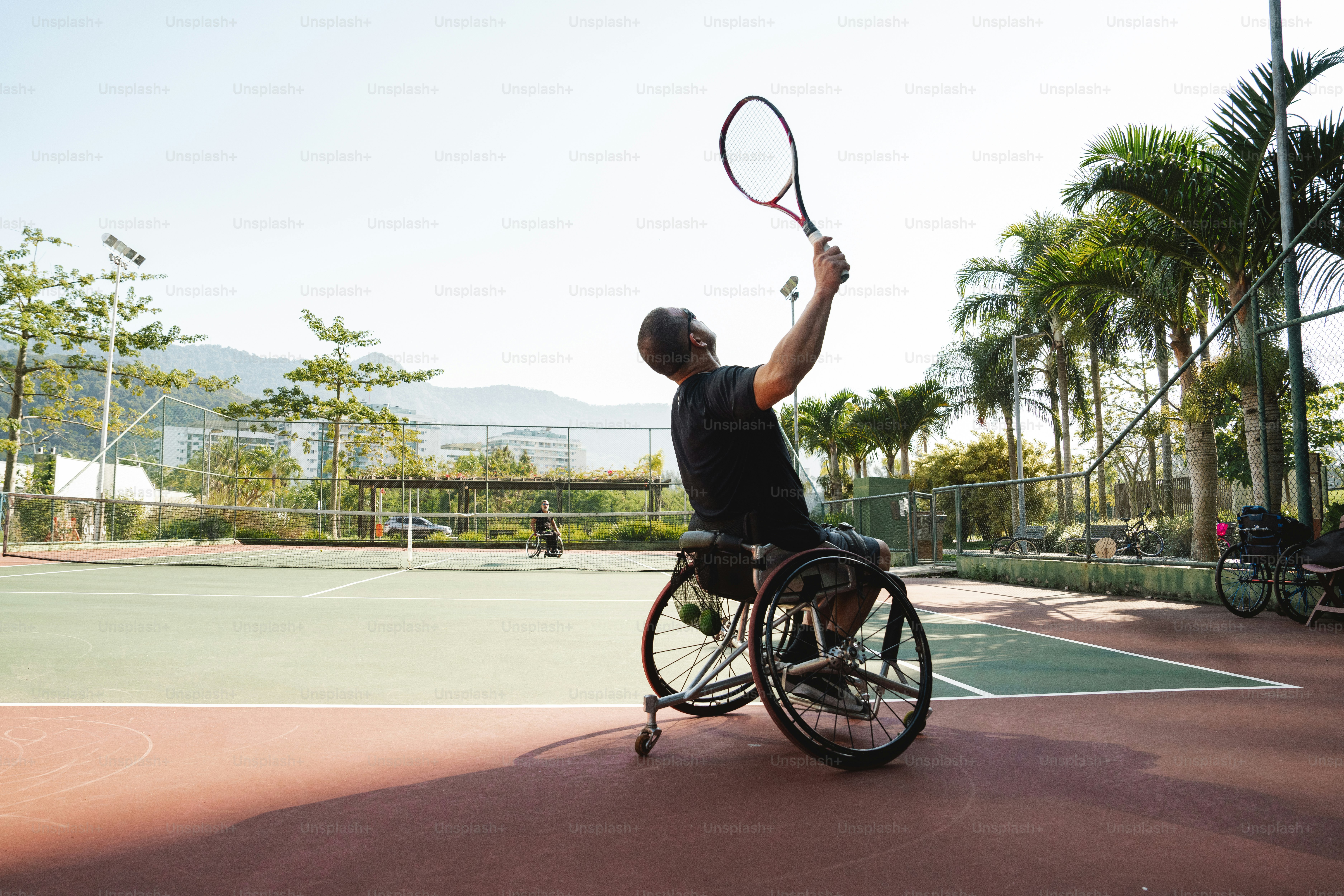 A man in a wheel chair holding a tennis racket photo – Athlete Image on ...