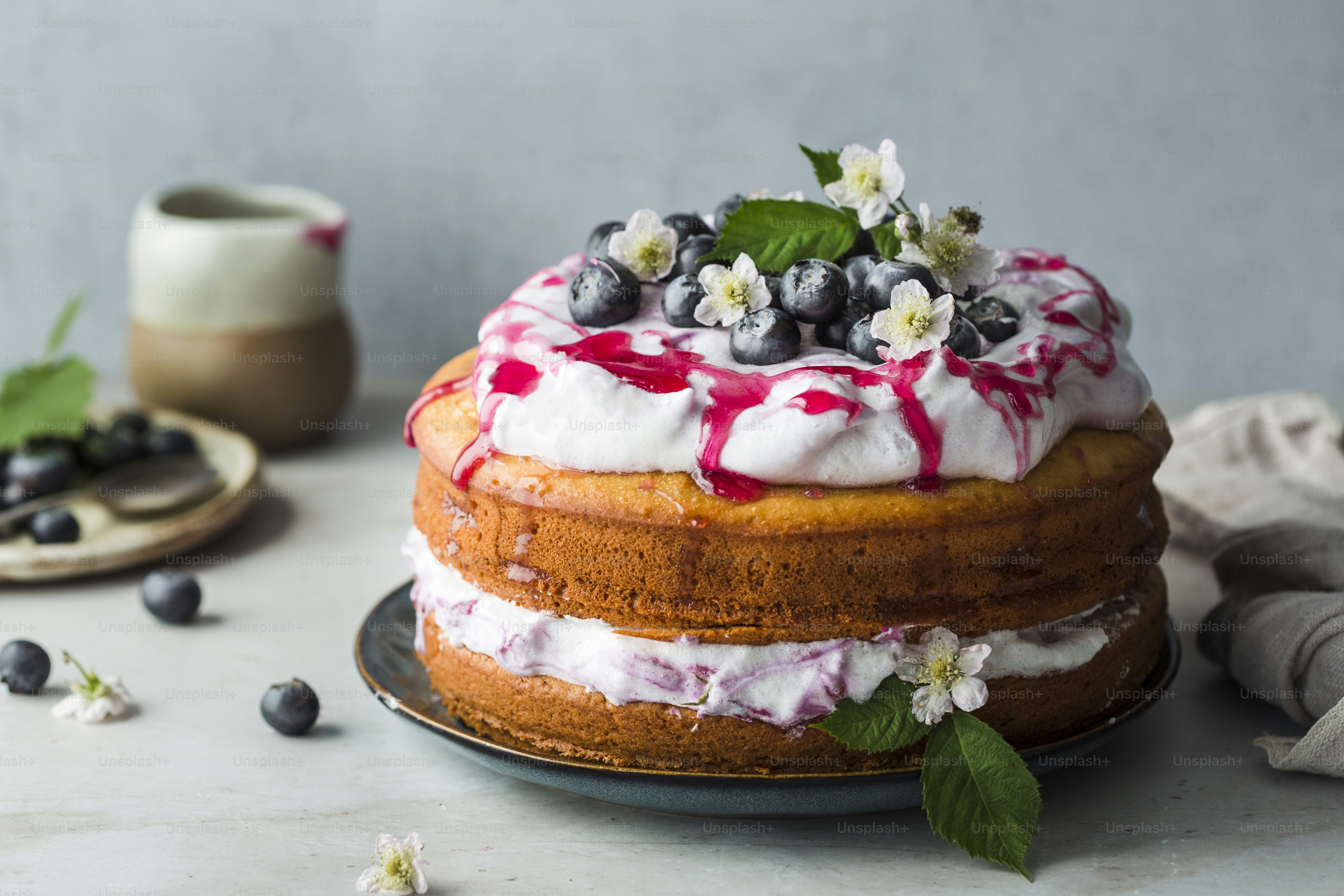 A cake with blueberries and whipped cream on top photo – Cakes Image on ...