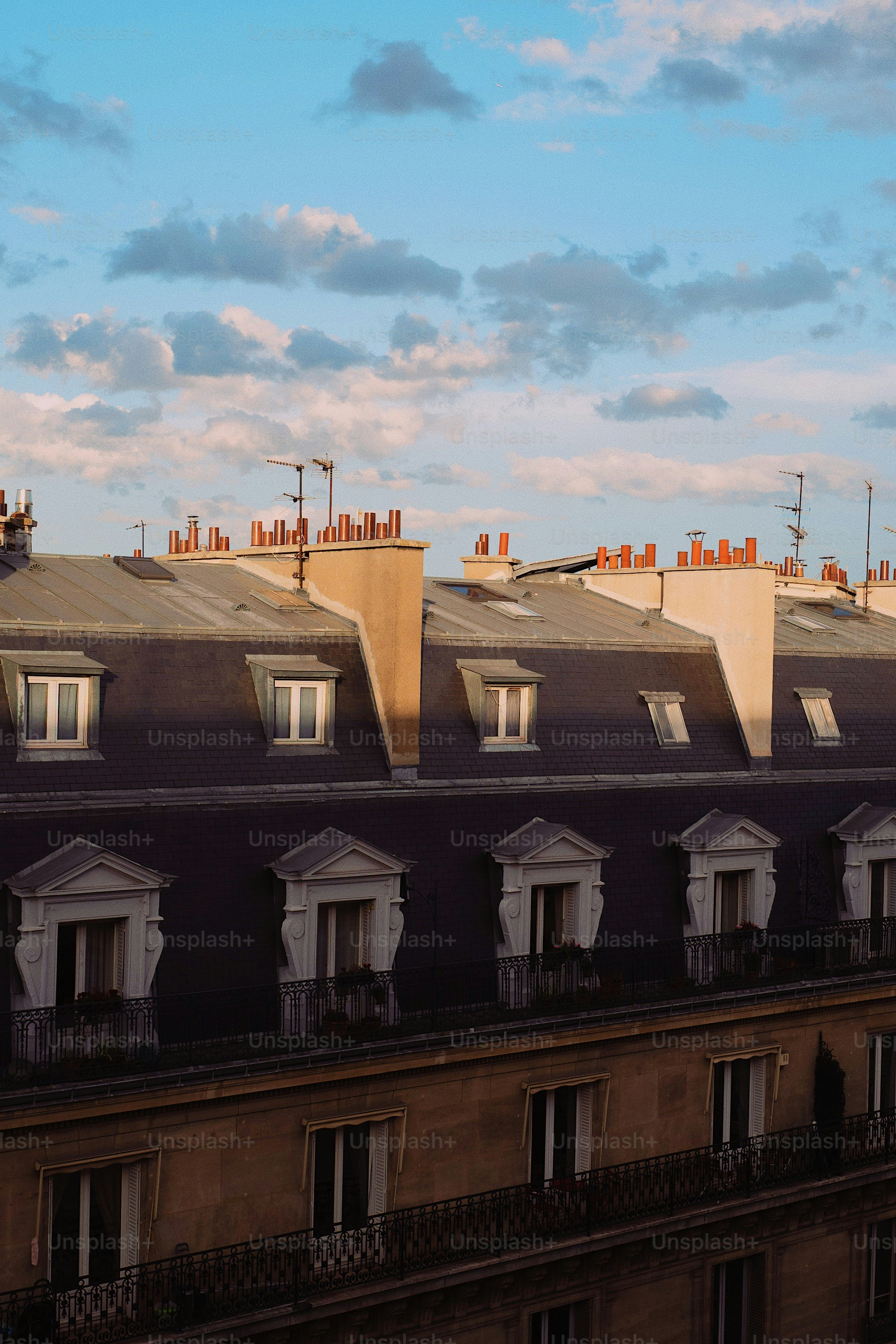 A row of buildings with a sky background photo – French architecture ...