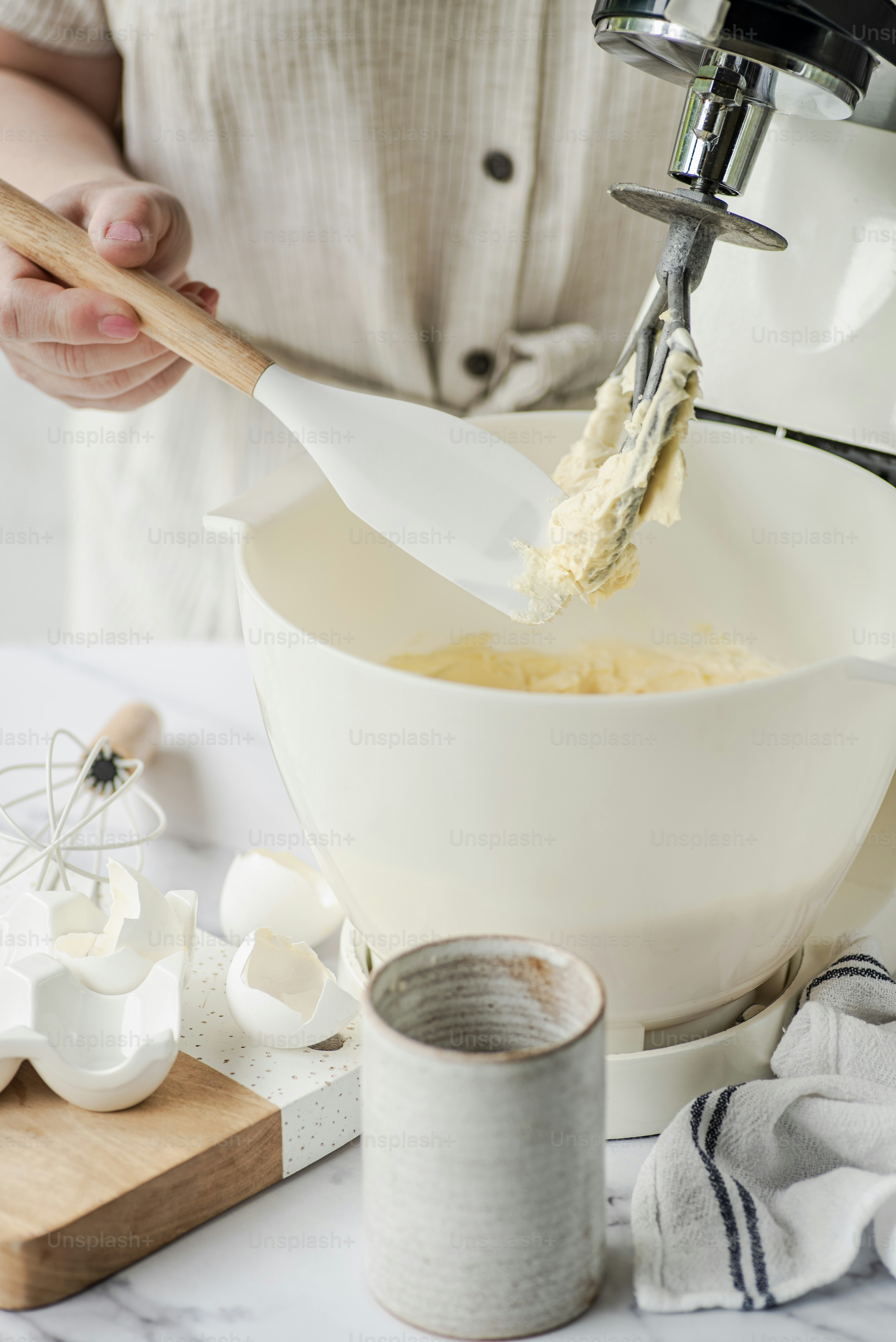 A person is mixing something in a bowl photo – Cooking with technology ...