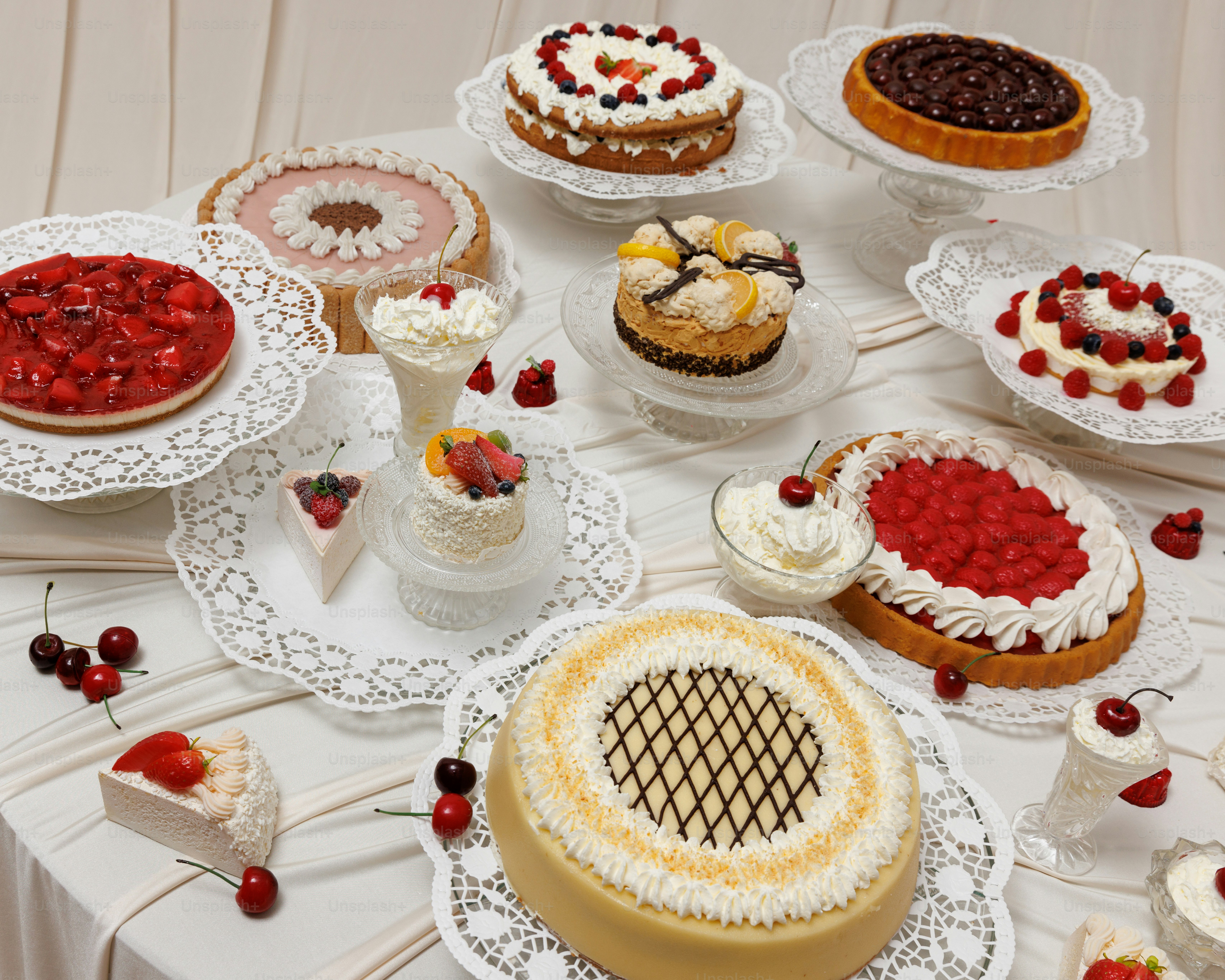 A table topped with lots of cakes and pies photo – Red bow Image on ...