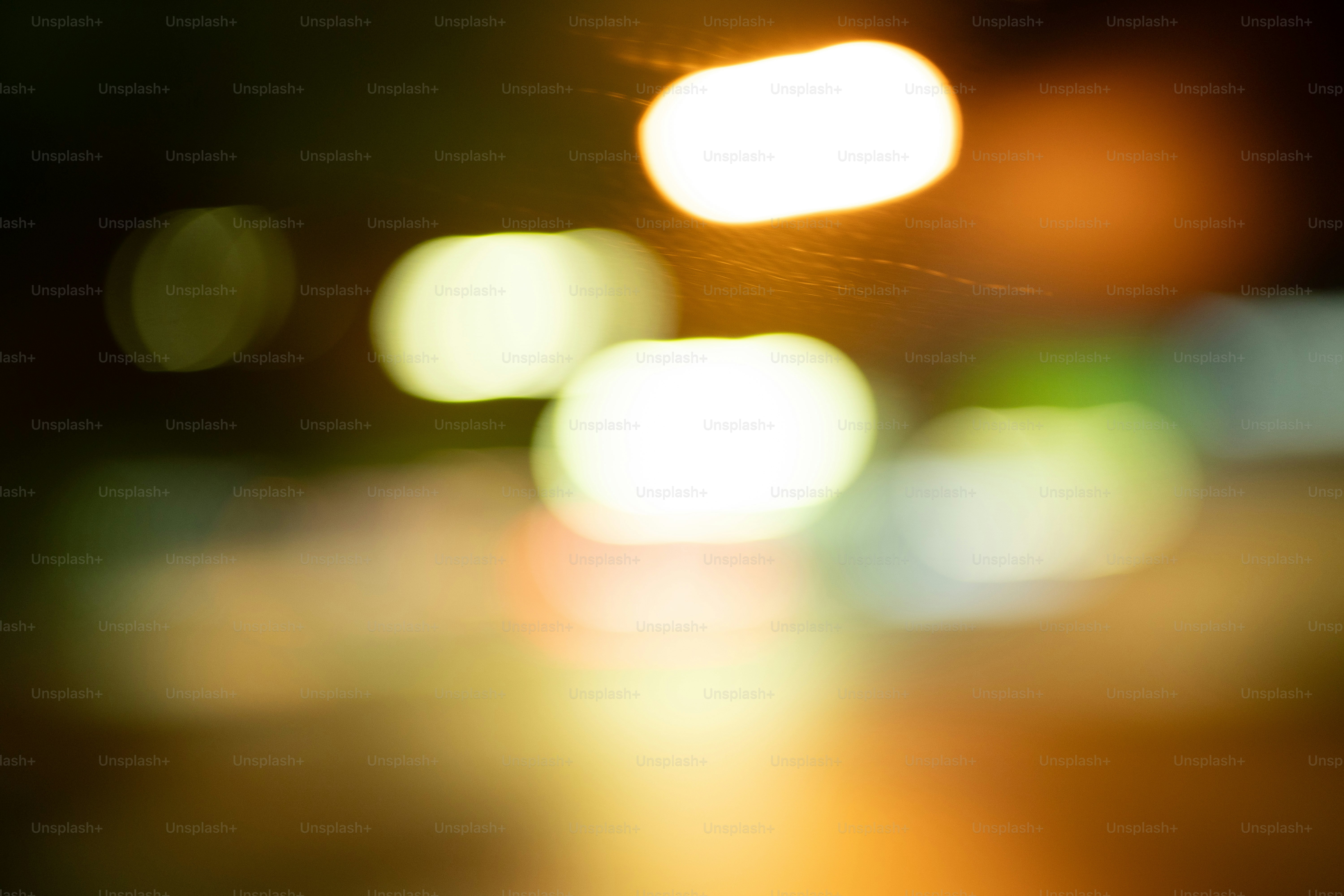 A blurry photo of a street light at night photo – Bokeh Image on Unsplash