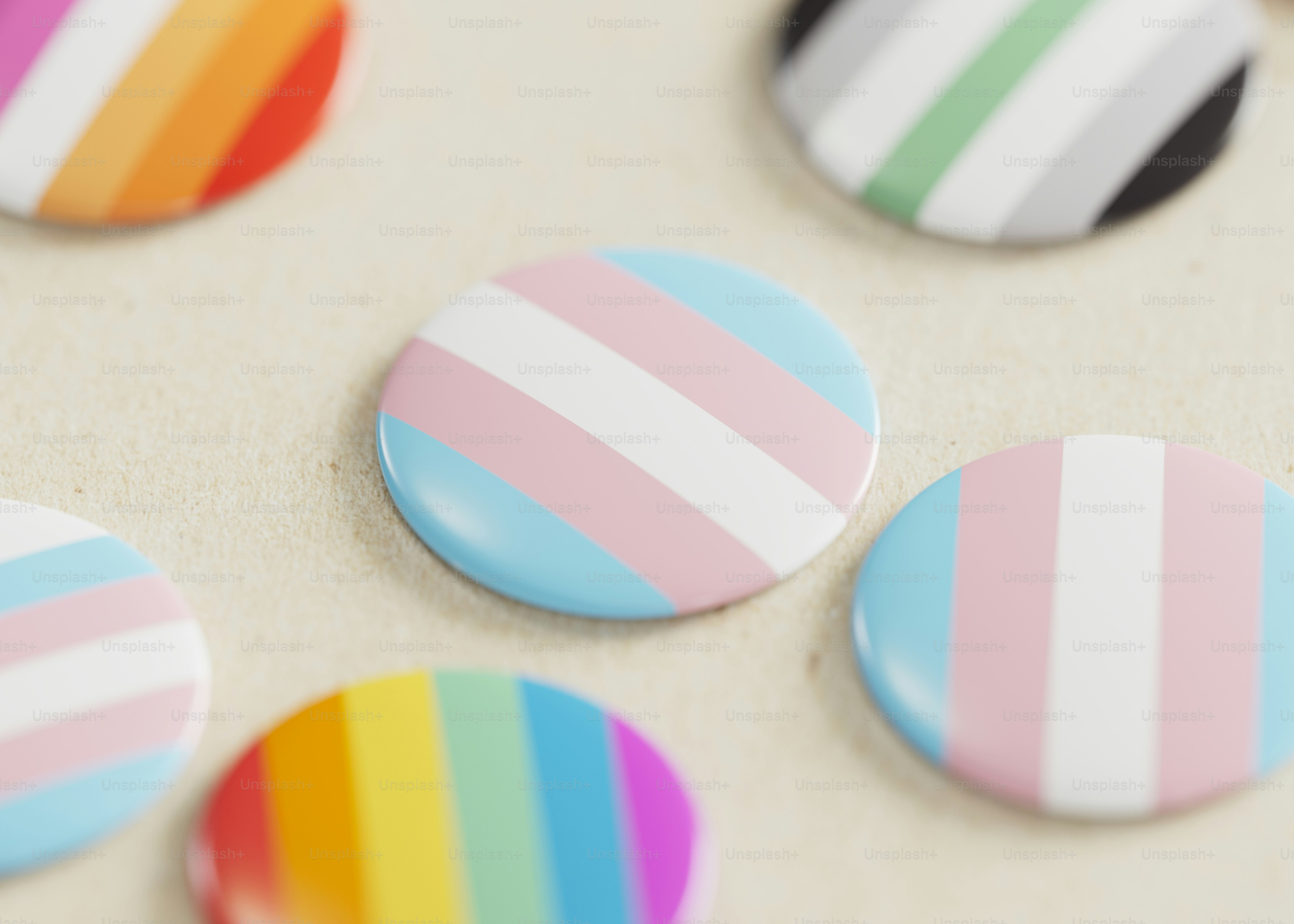 A close up of a bunch of buttons on a table photo – Pride Image on Unsplash