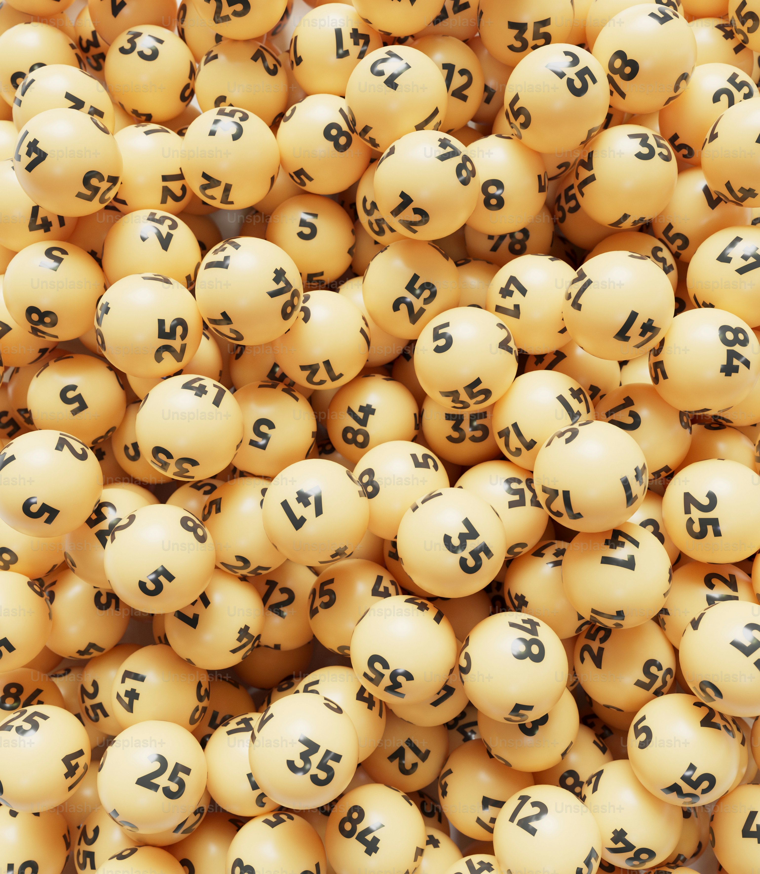 A pile of yellow balls with numbers on them photo – Numbered balls ...