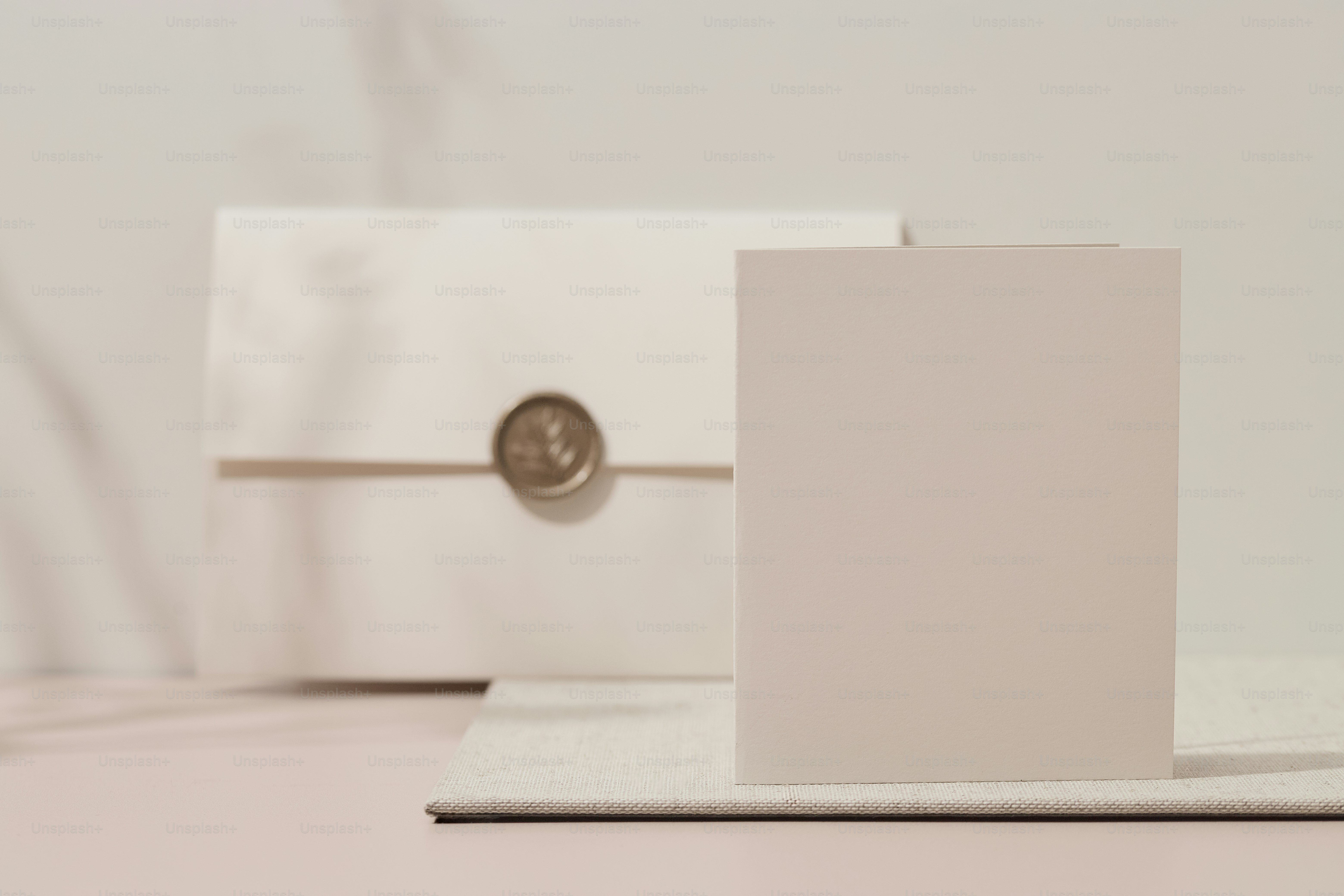 A white envelope sitting on top of a table photo – Invitations Image on ...