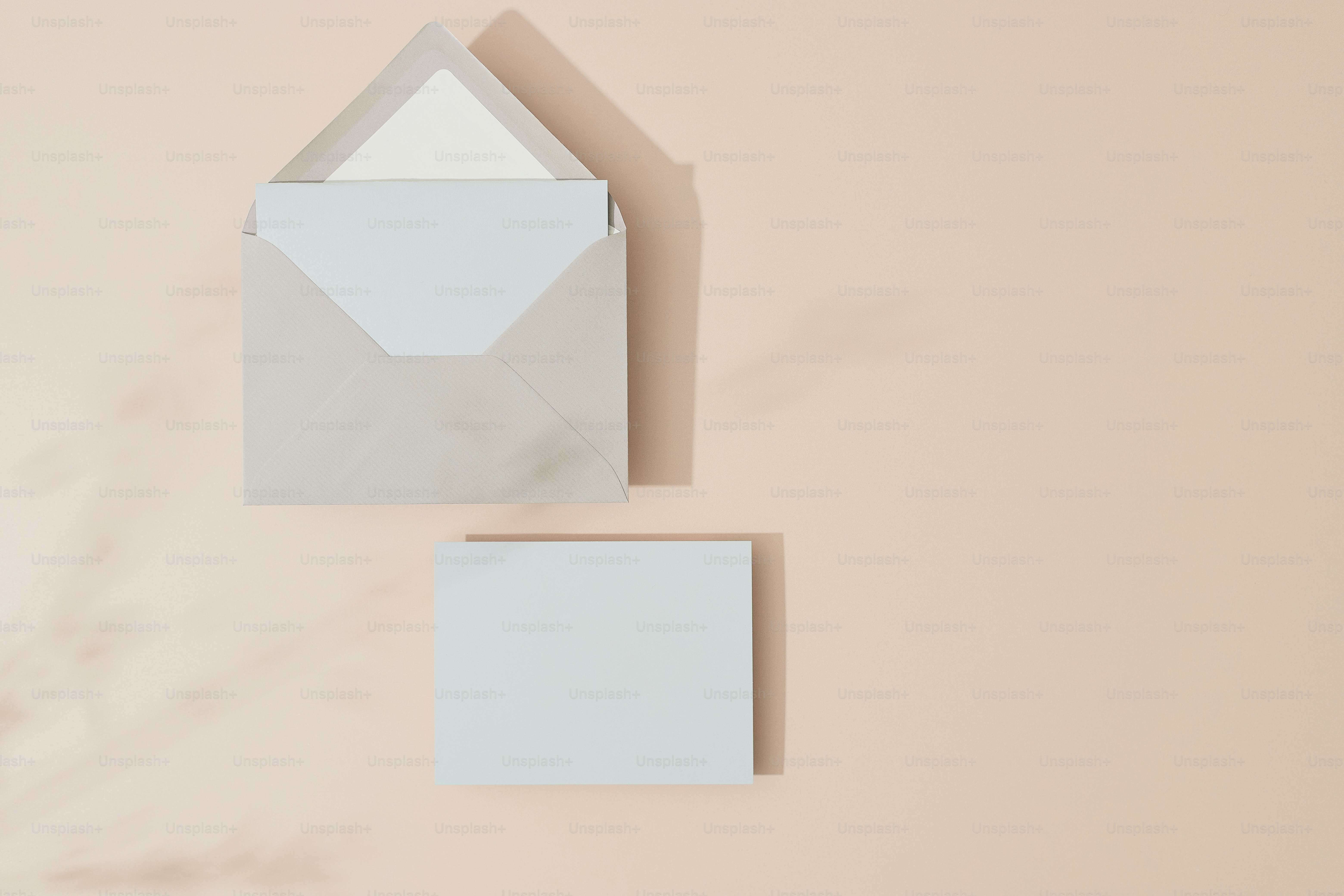 A white envelope and a white card on a pink background photo – Envelope ...