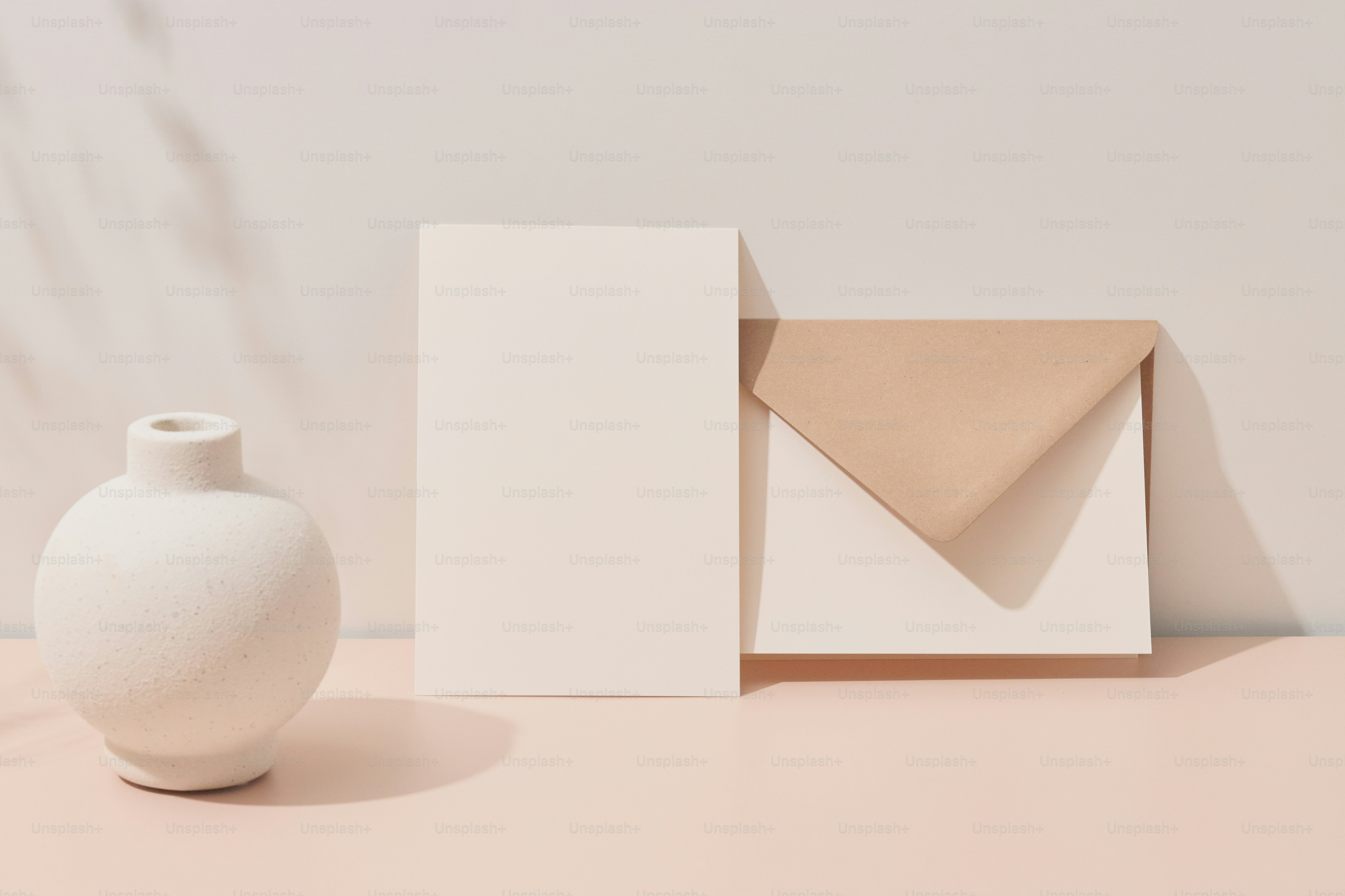 A white vase sitting next to a blank card photo – Invitations Image on ...