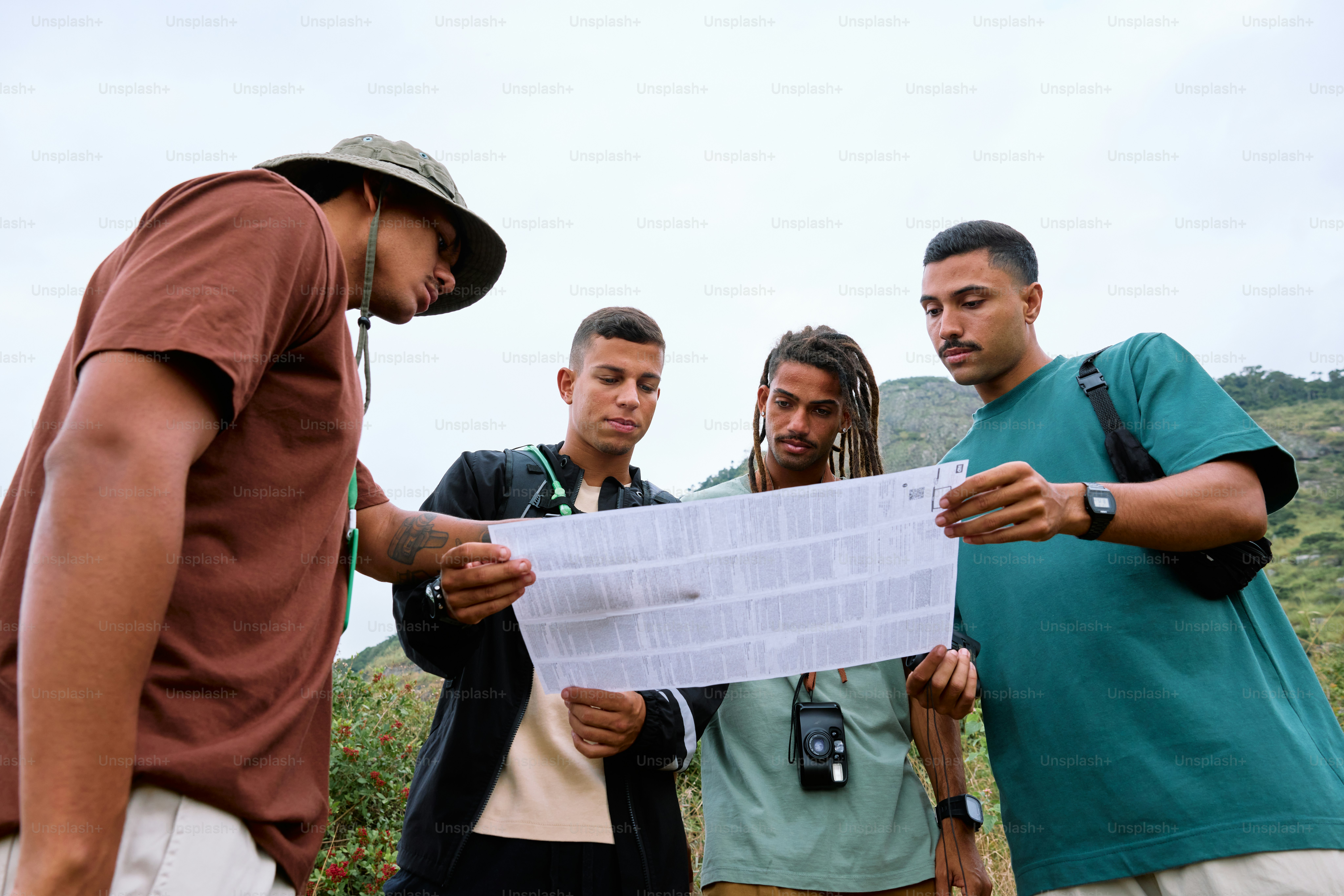 A group of men looking at a map photo – Map Image on Unsplash