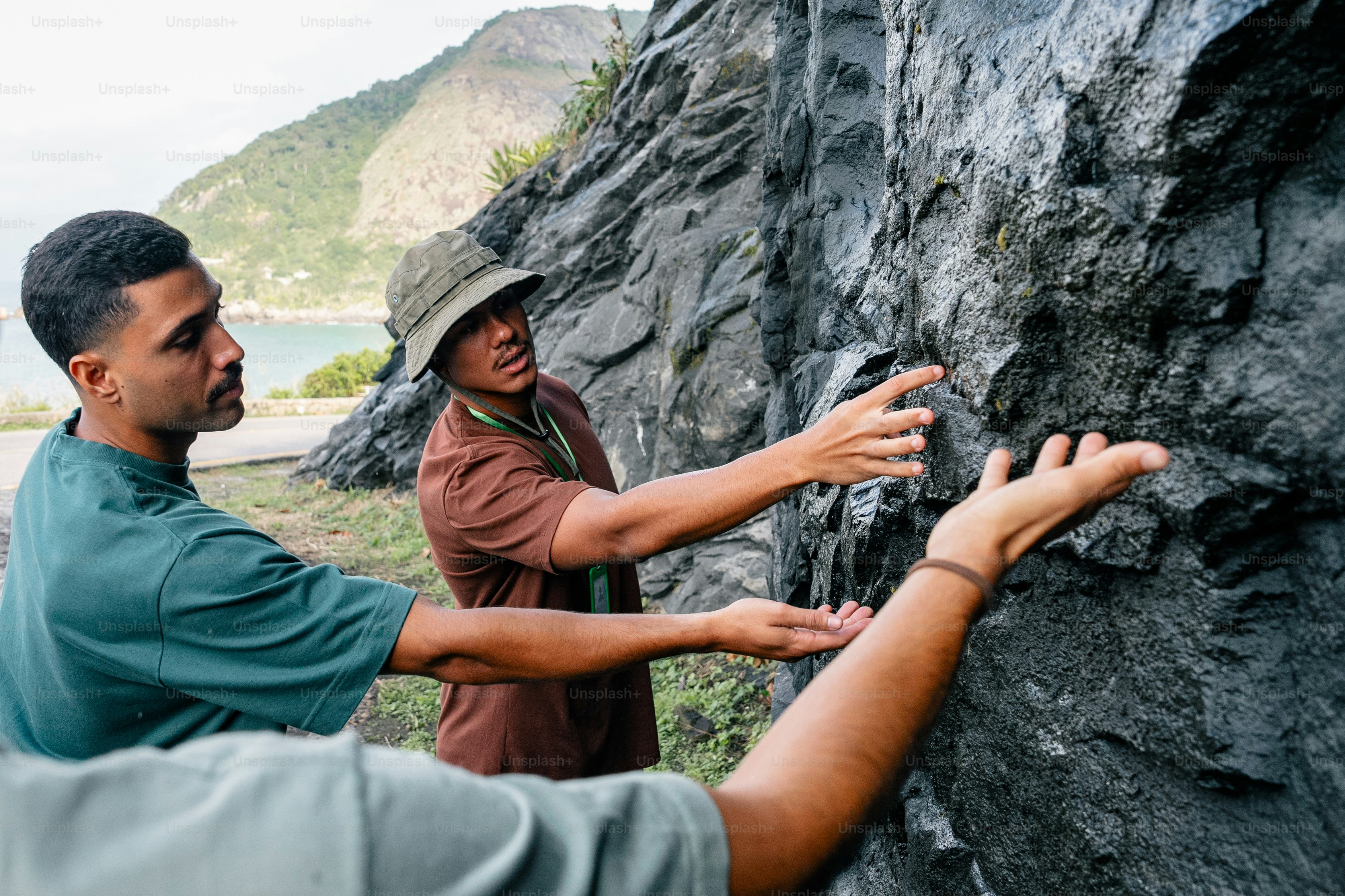 A couple of people that are touching a rock photo – Tours Image on Unsplash