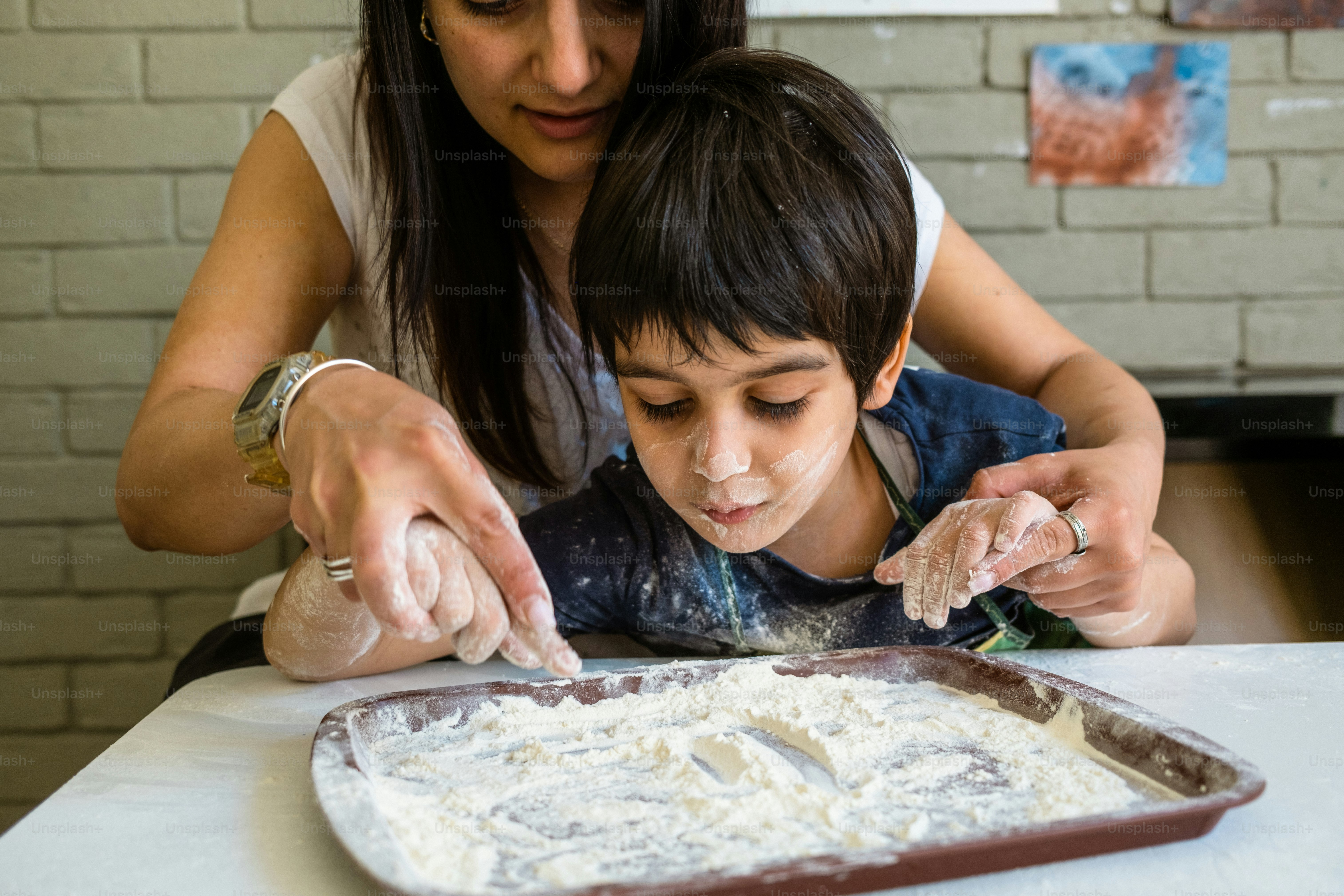 A woman and a child are making food photo – Autistic child Image on ...