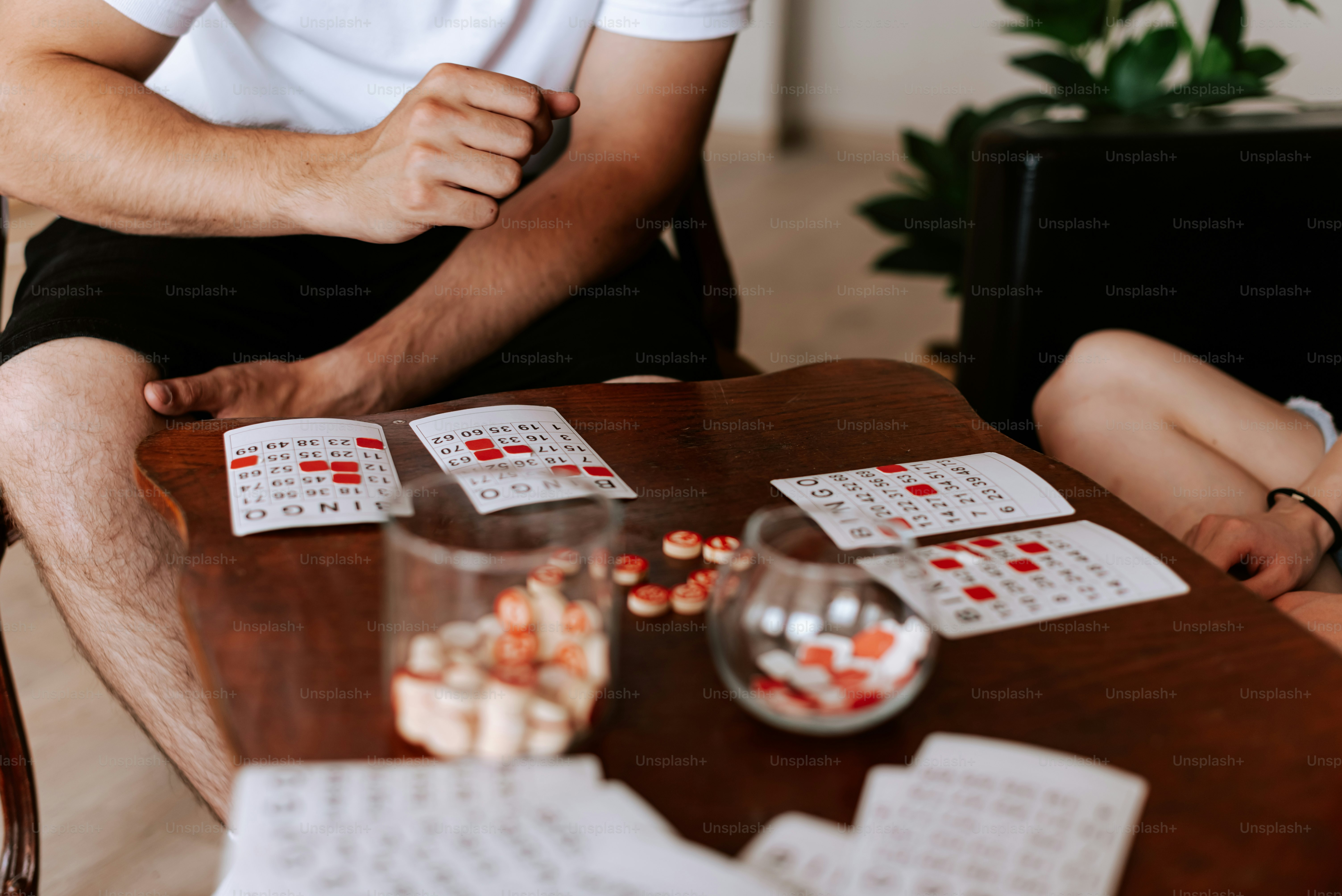 A man and a woman sitting at a table with playing cards photo – Bingo ...