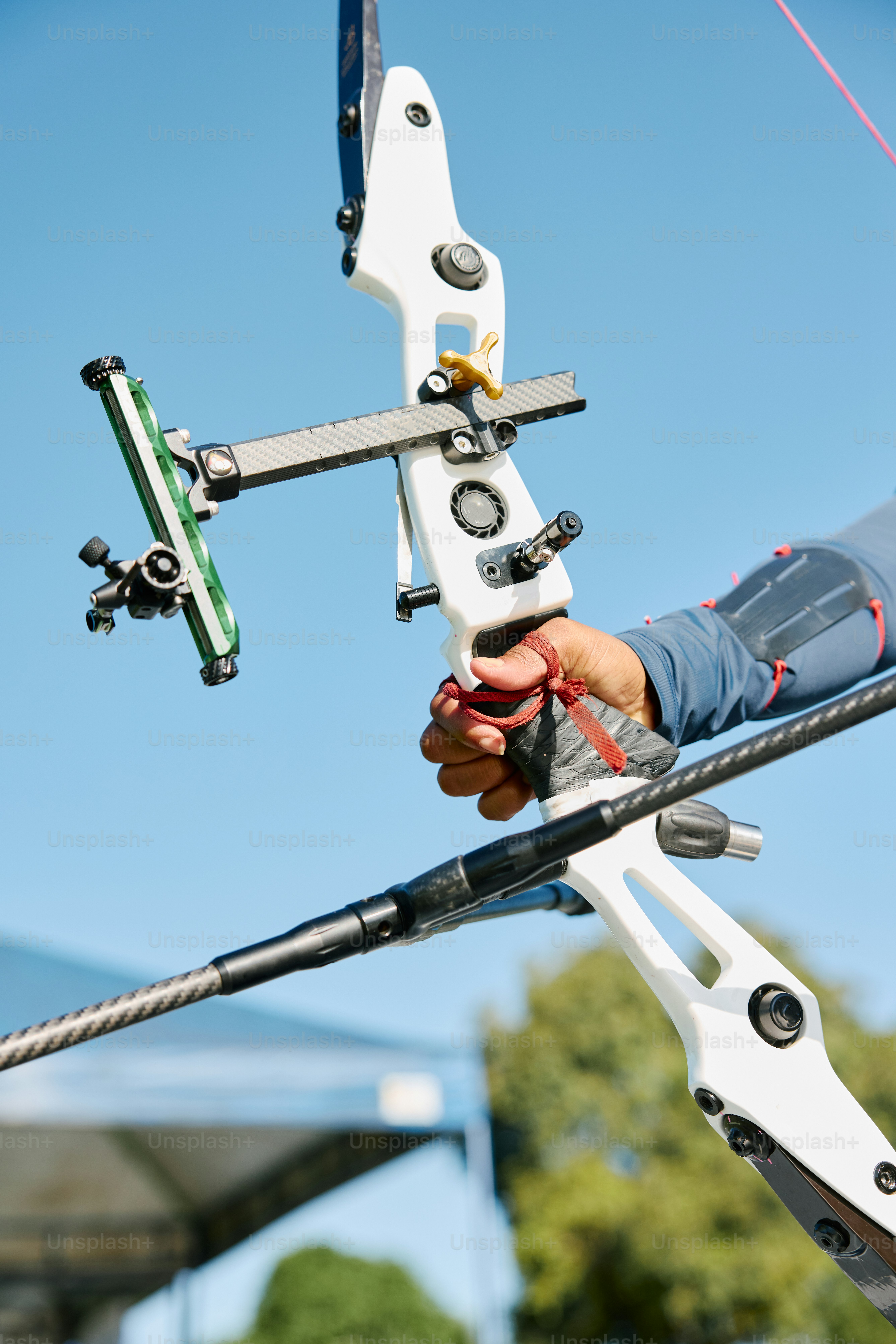 A person is holding a bow and aiming it photo – Woman Image on Unsplash