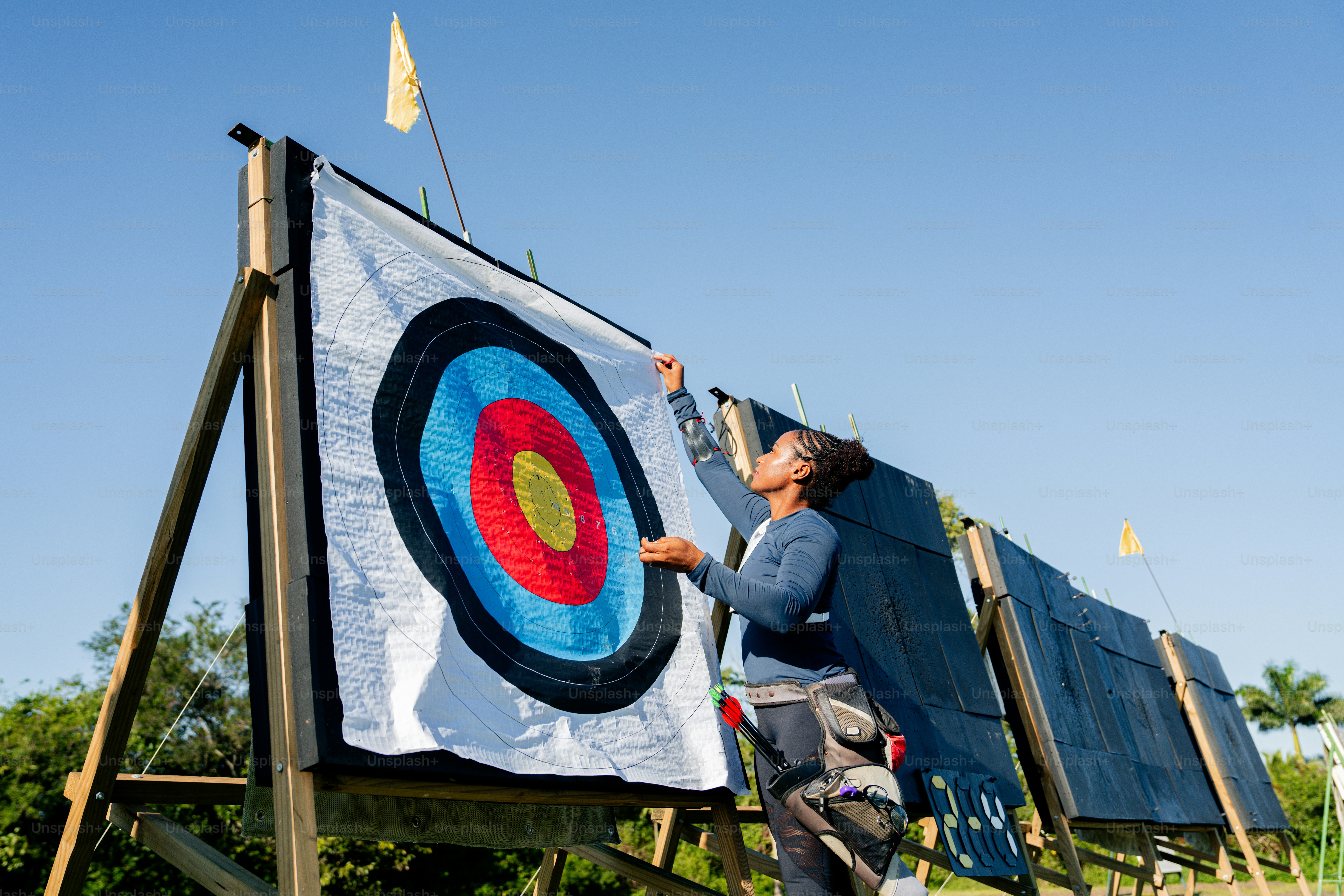 A man holding up a large archery target photo – Archery Image on Unsplash