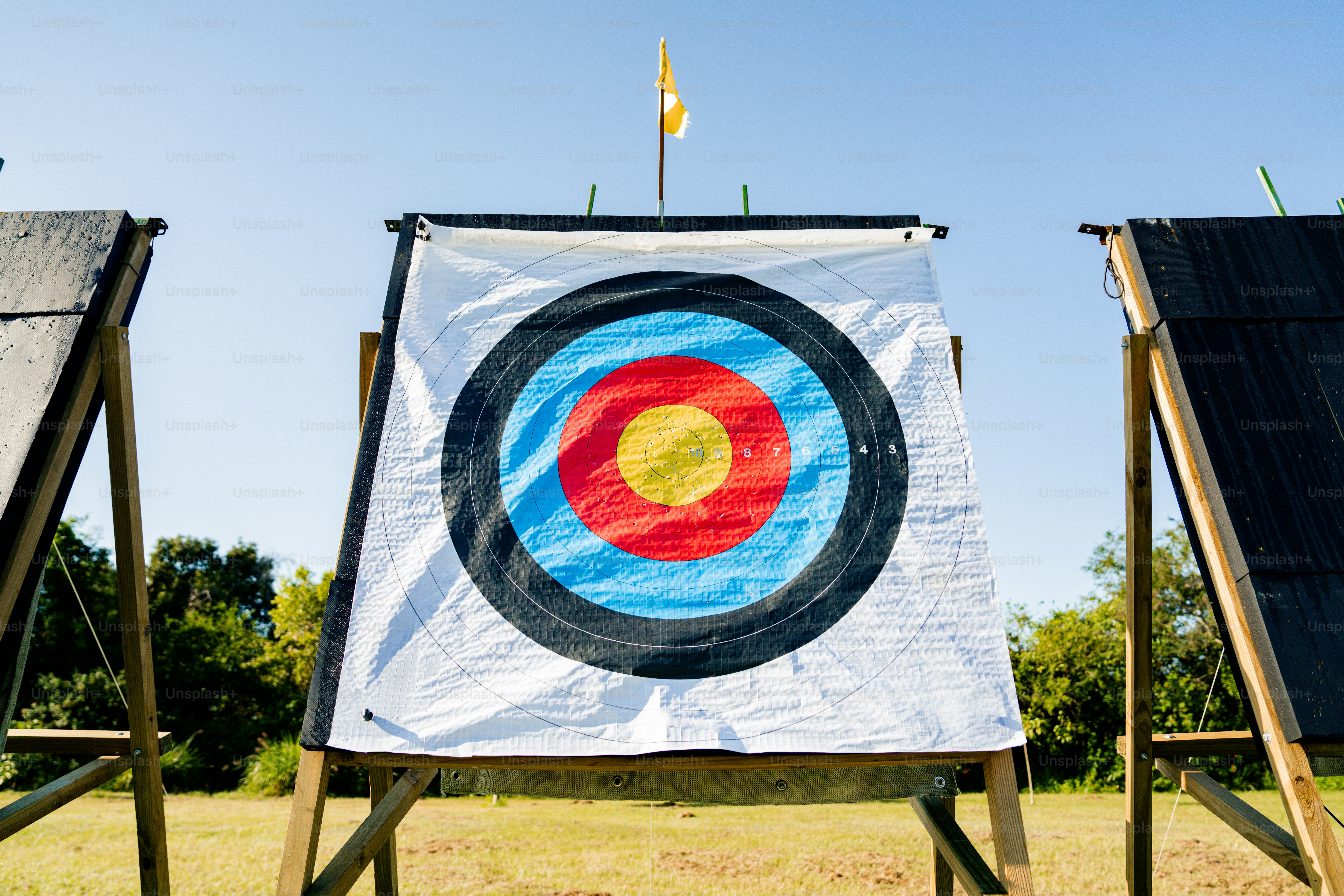 A white banner with a red, blue, and yellow target on it photo ...