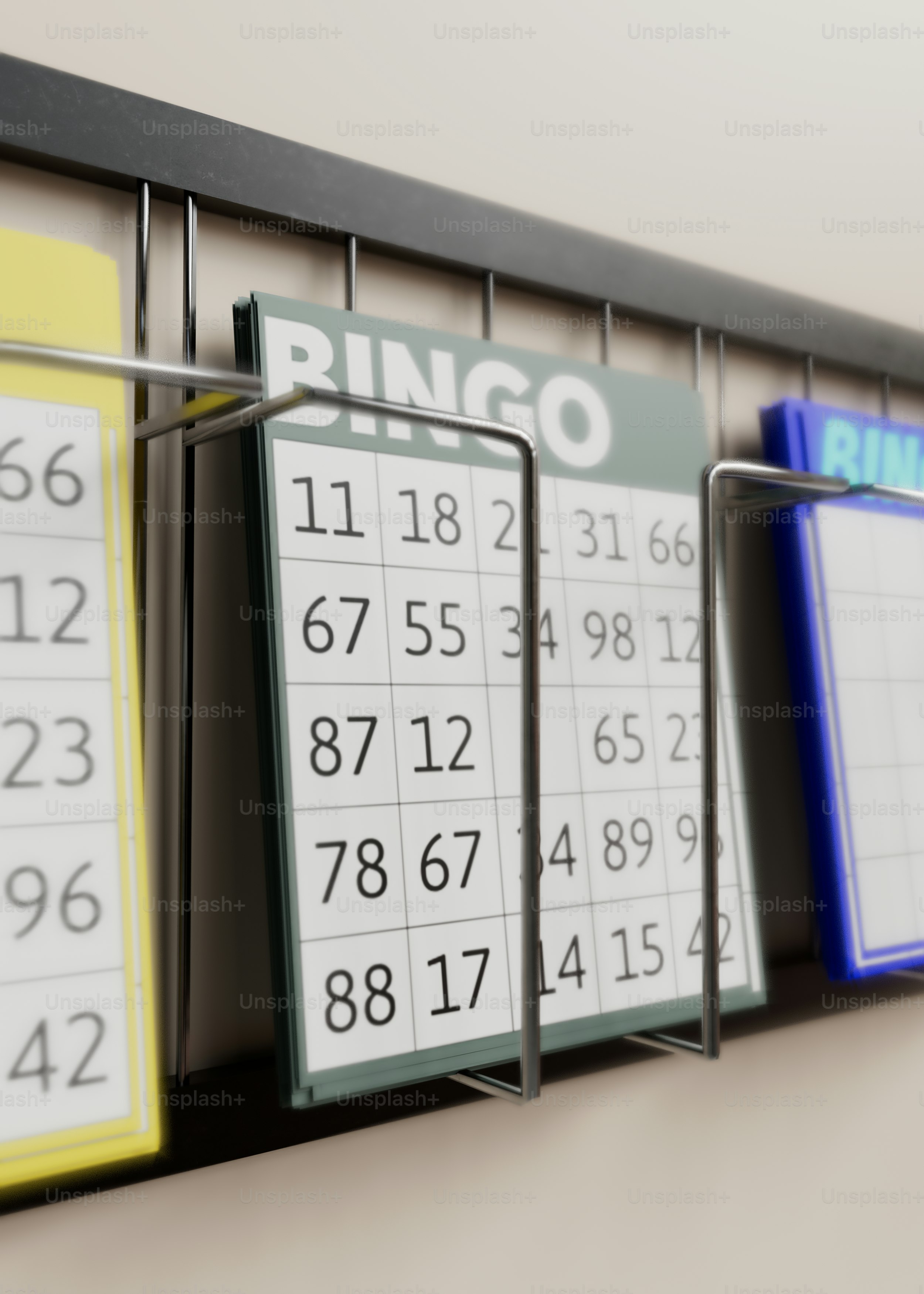 A metal rack with three calendars attached to it photo – Bingo Image on ...