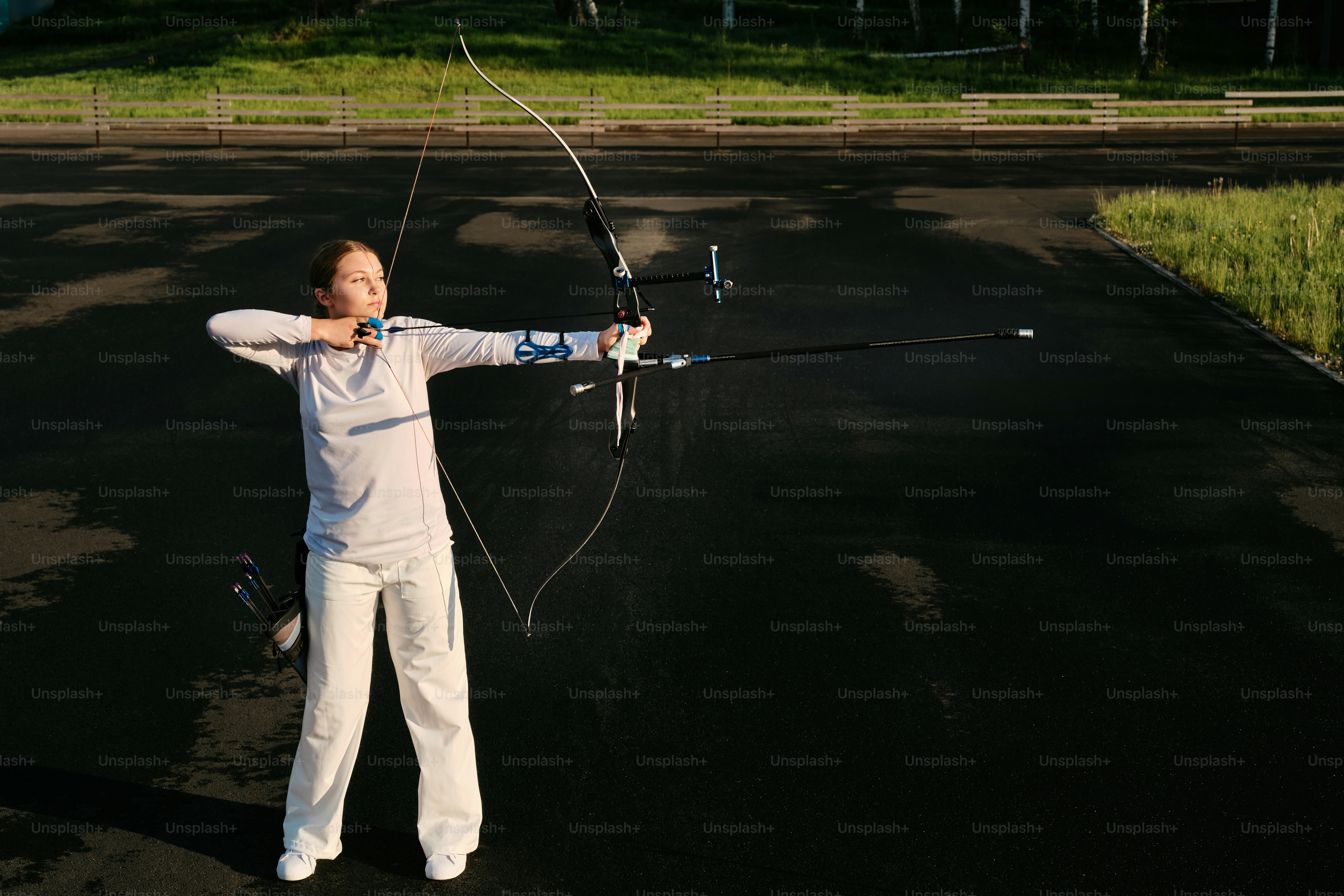 A young boy holding a bow and arrow photo – Archer Image on Unsplash