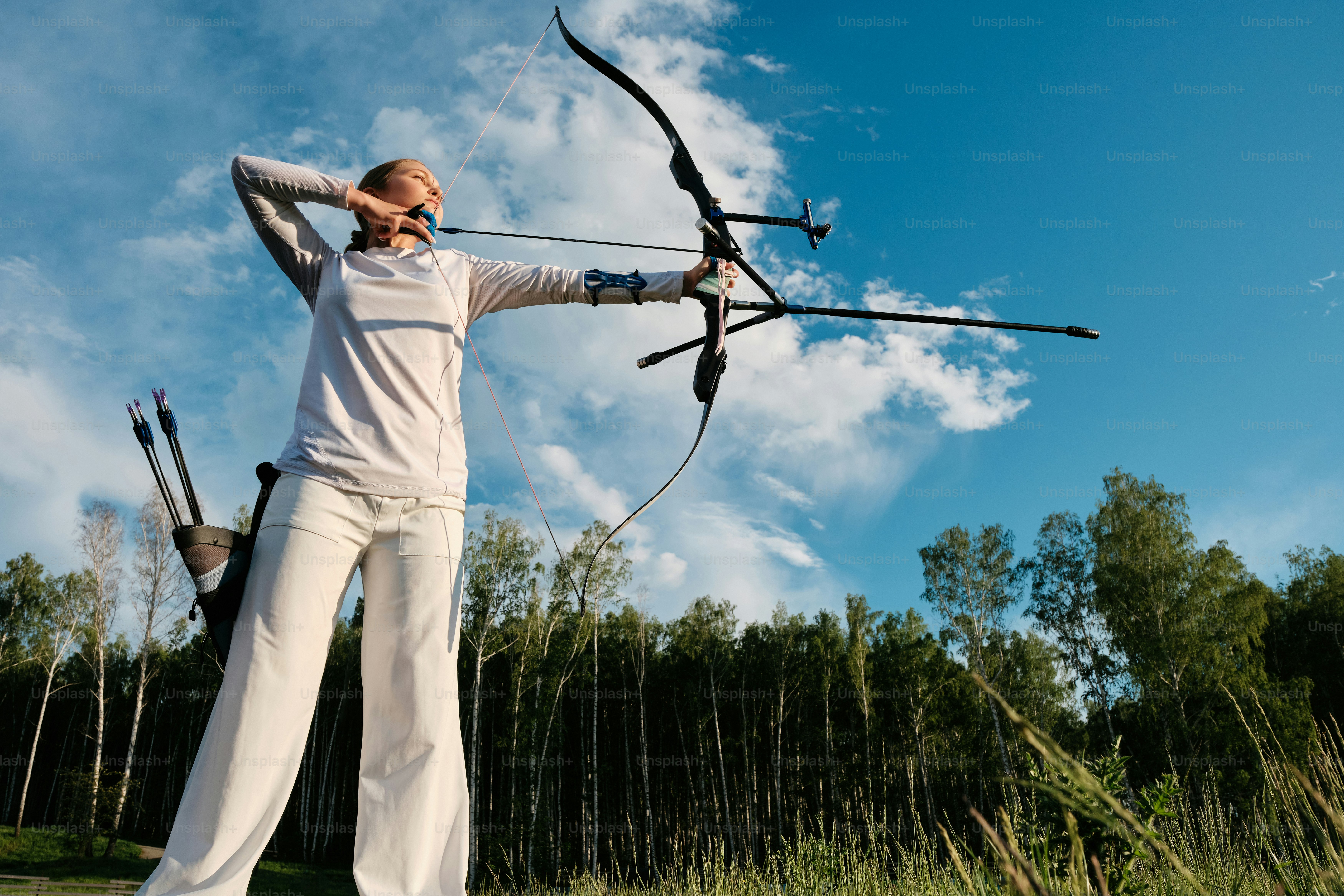 A woman holding a bow and arrows in her hands photo – Girl Image on ...