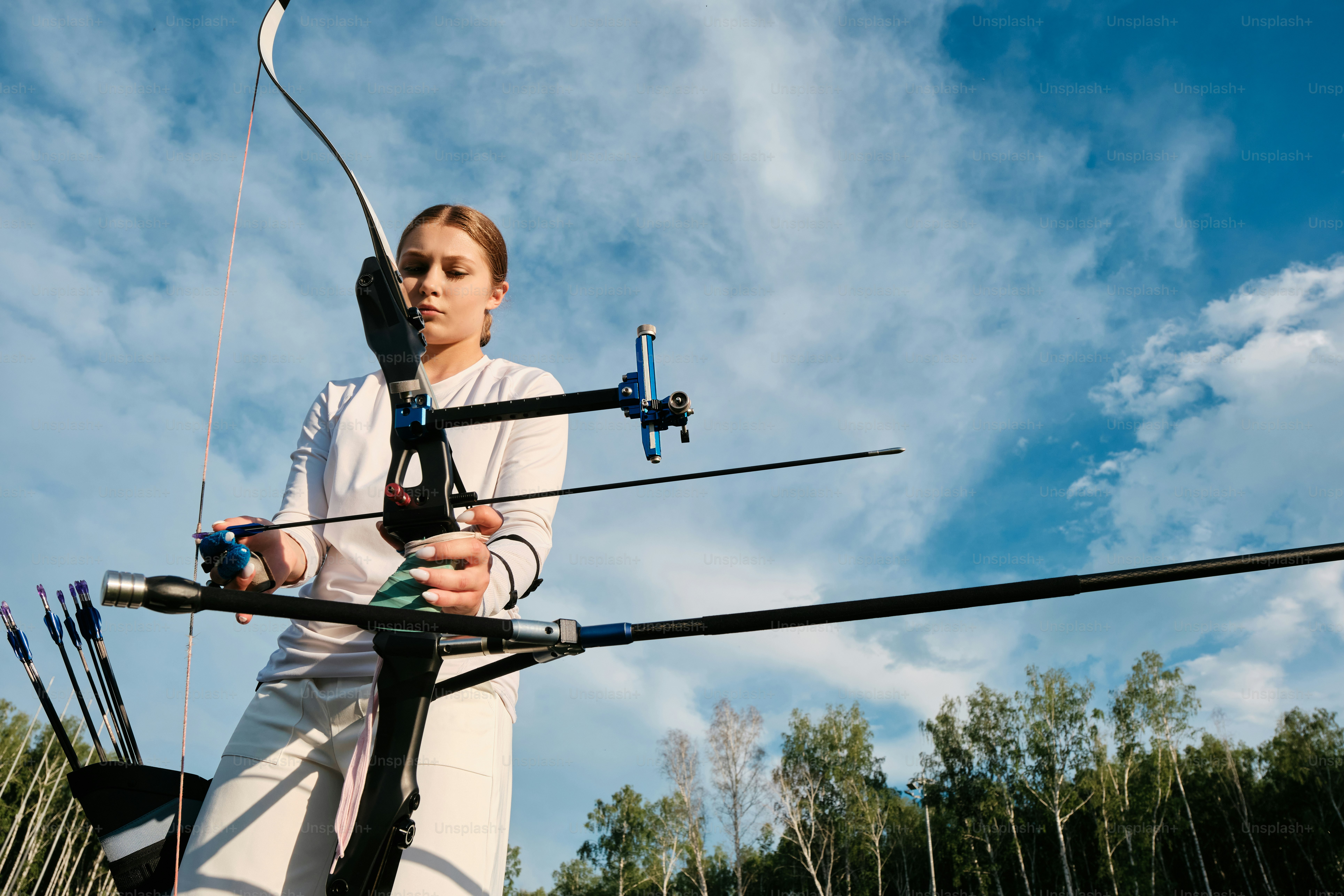 A woman is holding a bow and arrows photo – Archery Image on Unsplash