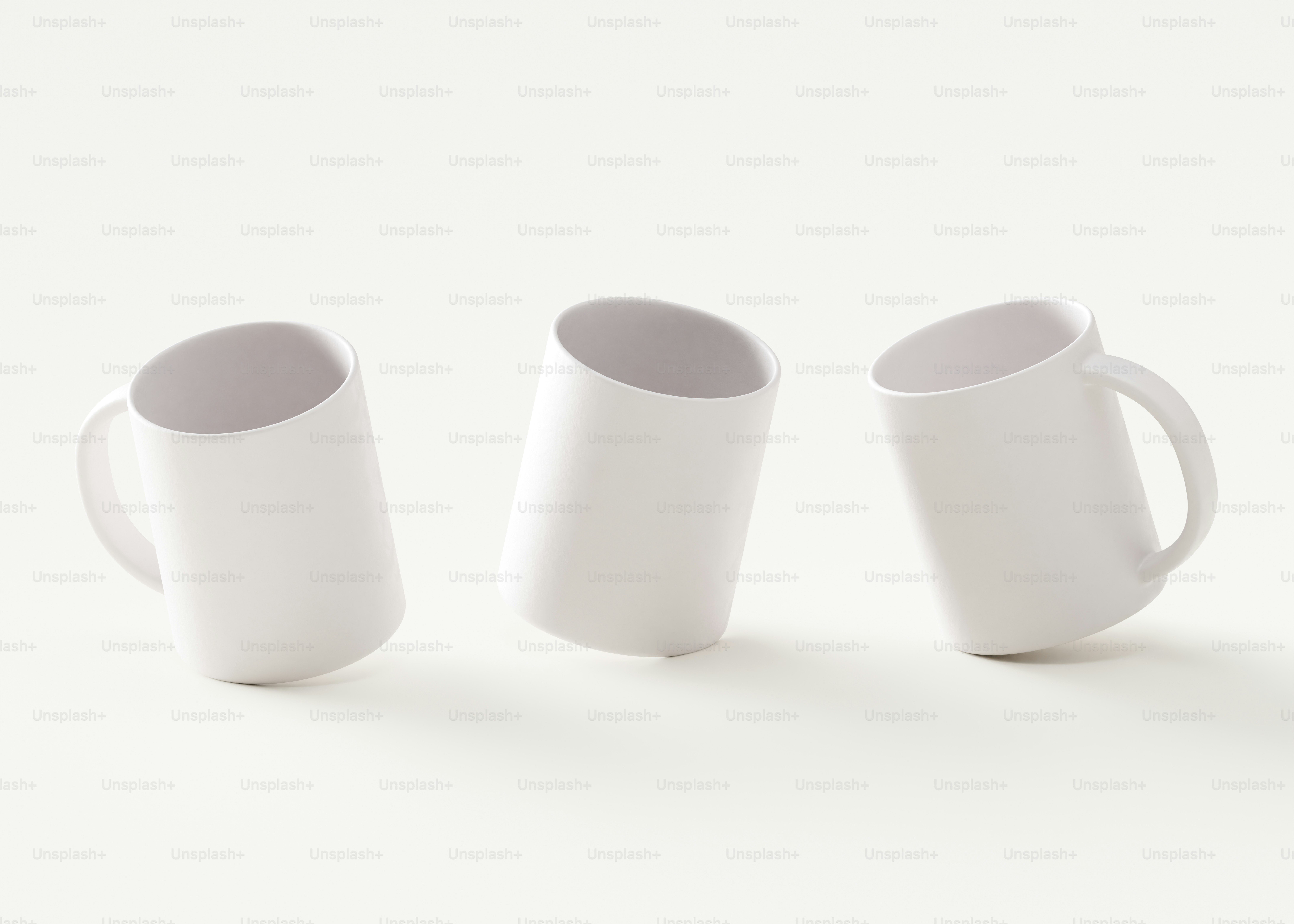 A stack of three cups sitting on top of a table photo – Mockup mug ...