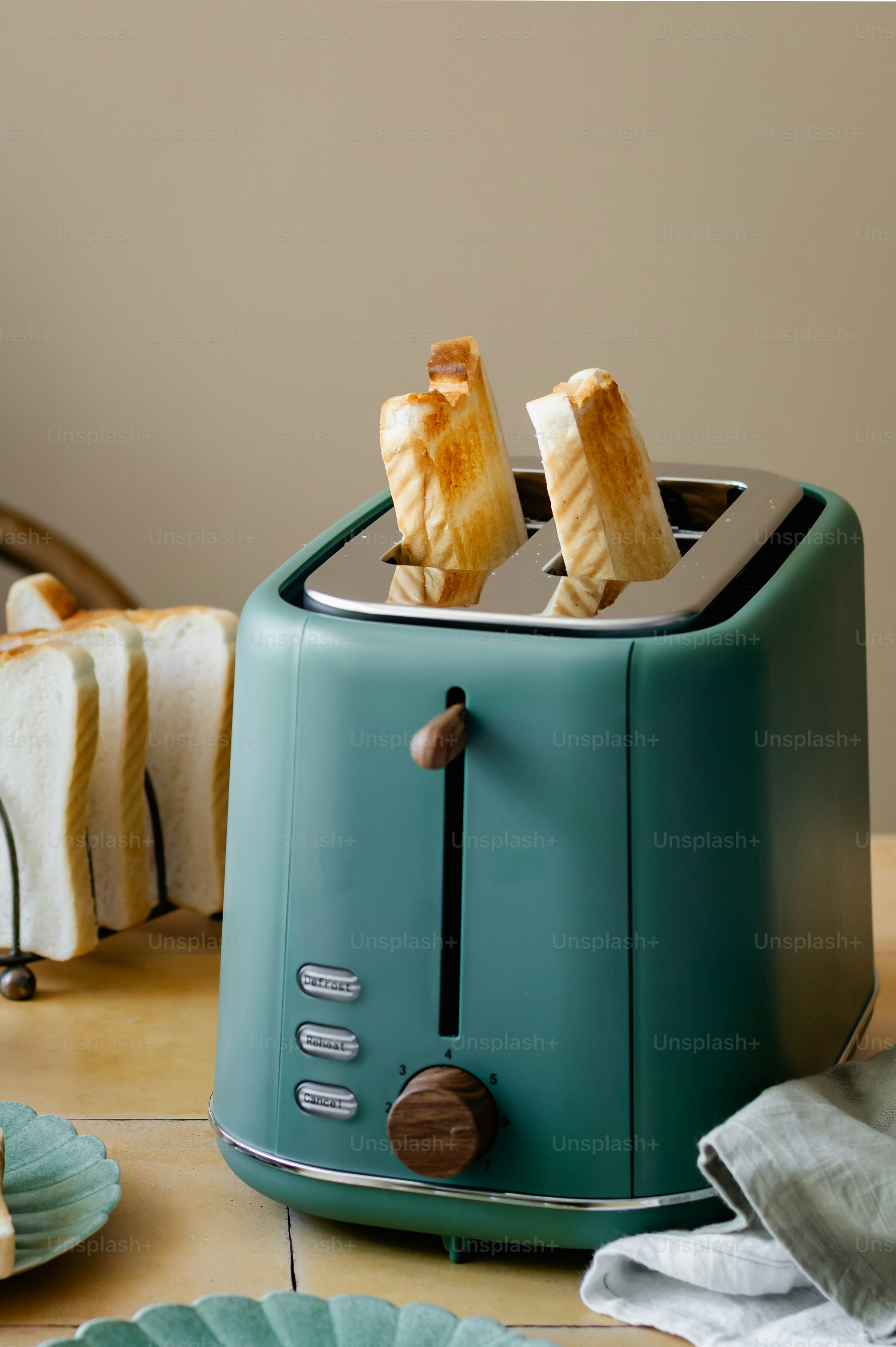A toaster with two pieces of bread sticking out of it photo – Food ...