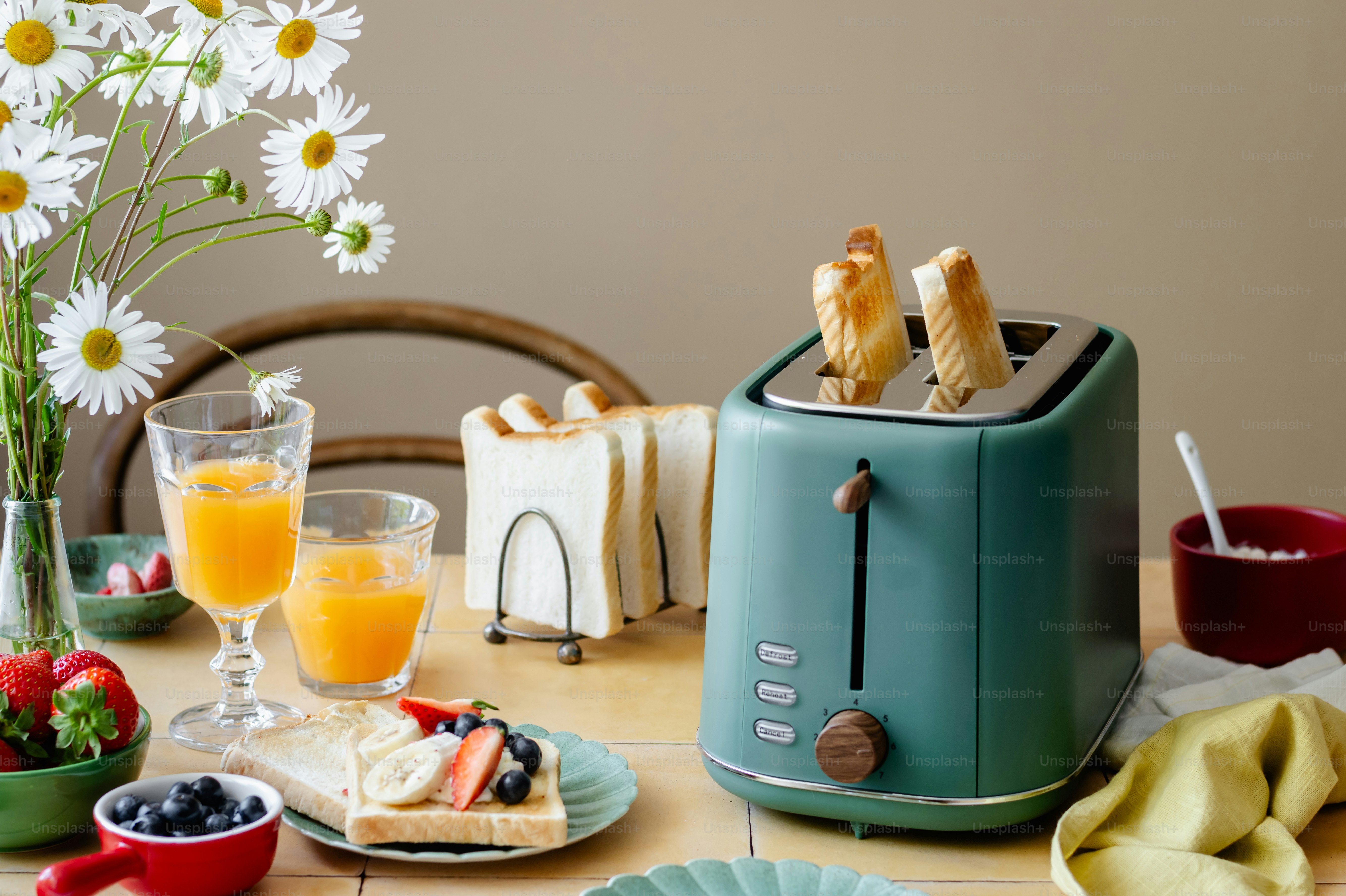 A toaster sitting on top of a wooden table photo – Cooking Image on ...