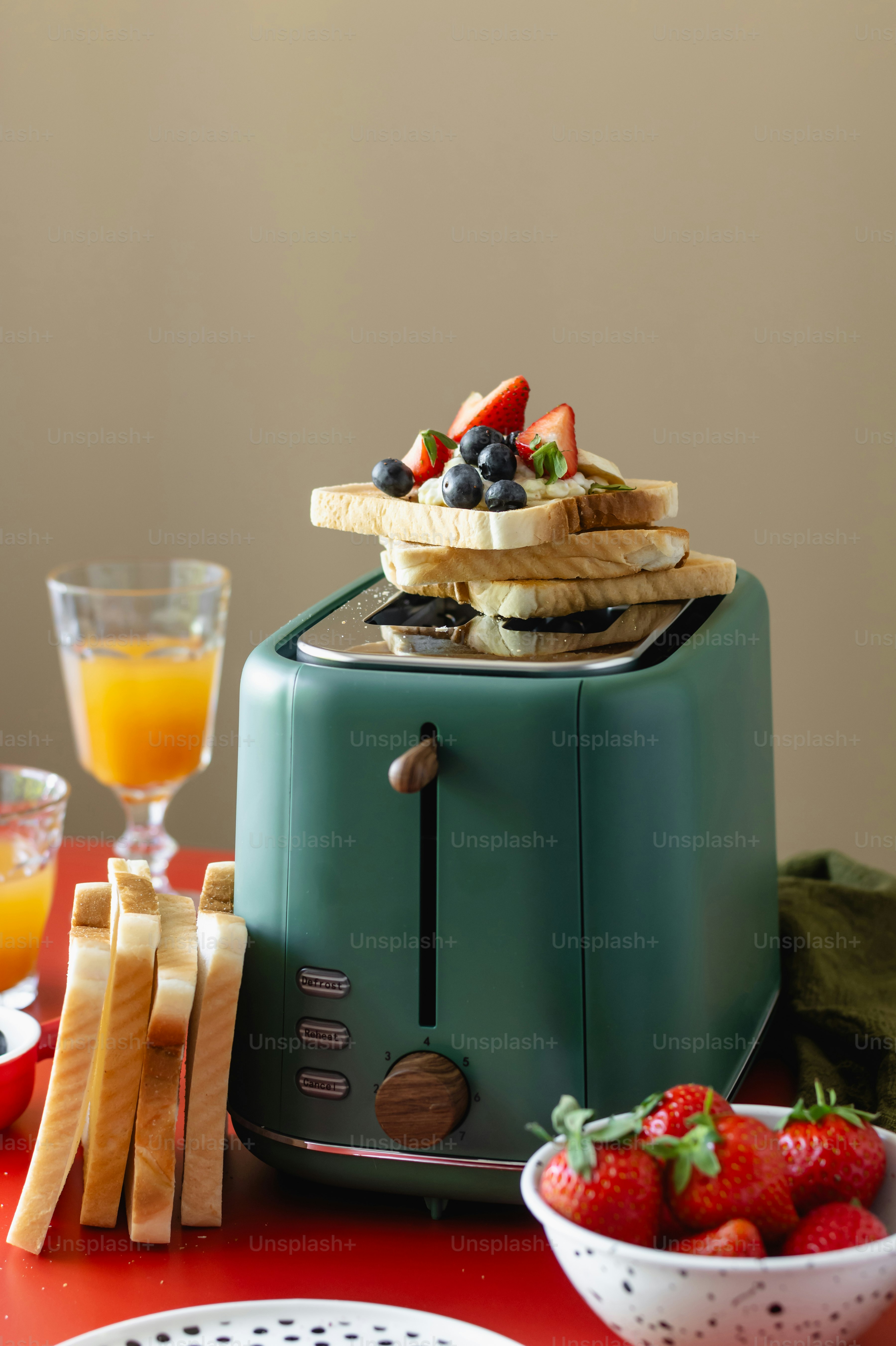 A green toaster sitting on top of a red table photo – Technology Image ...