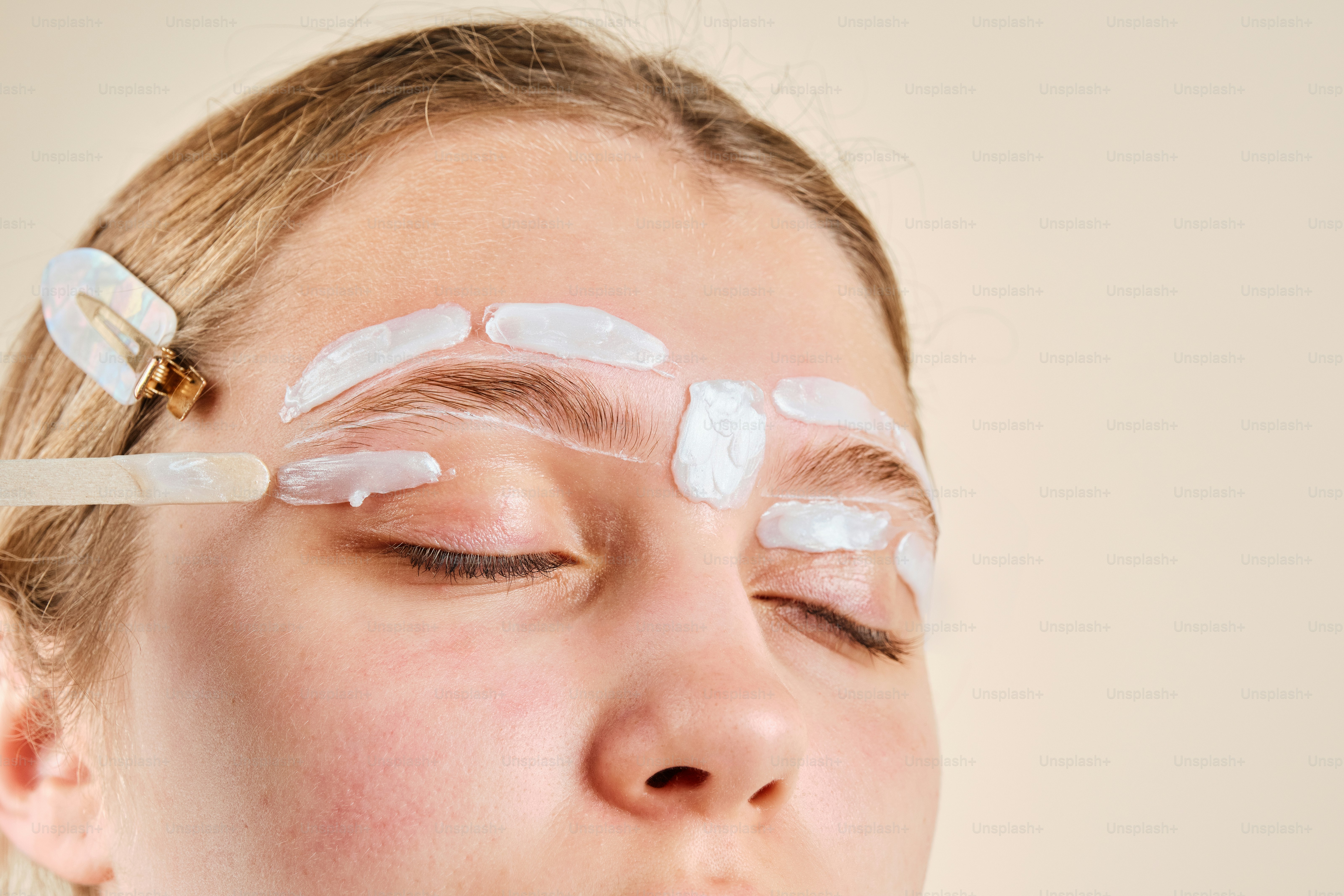 A woman with eyeliner tape on her eyes photo – Brow lamination Image on ...