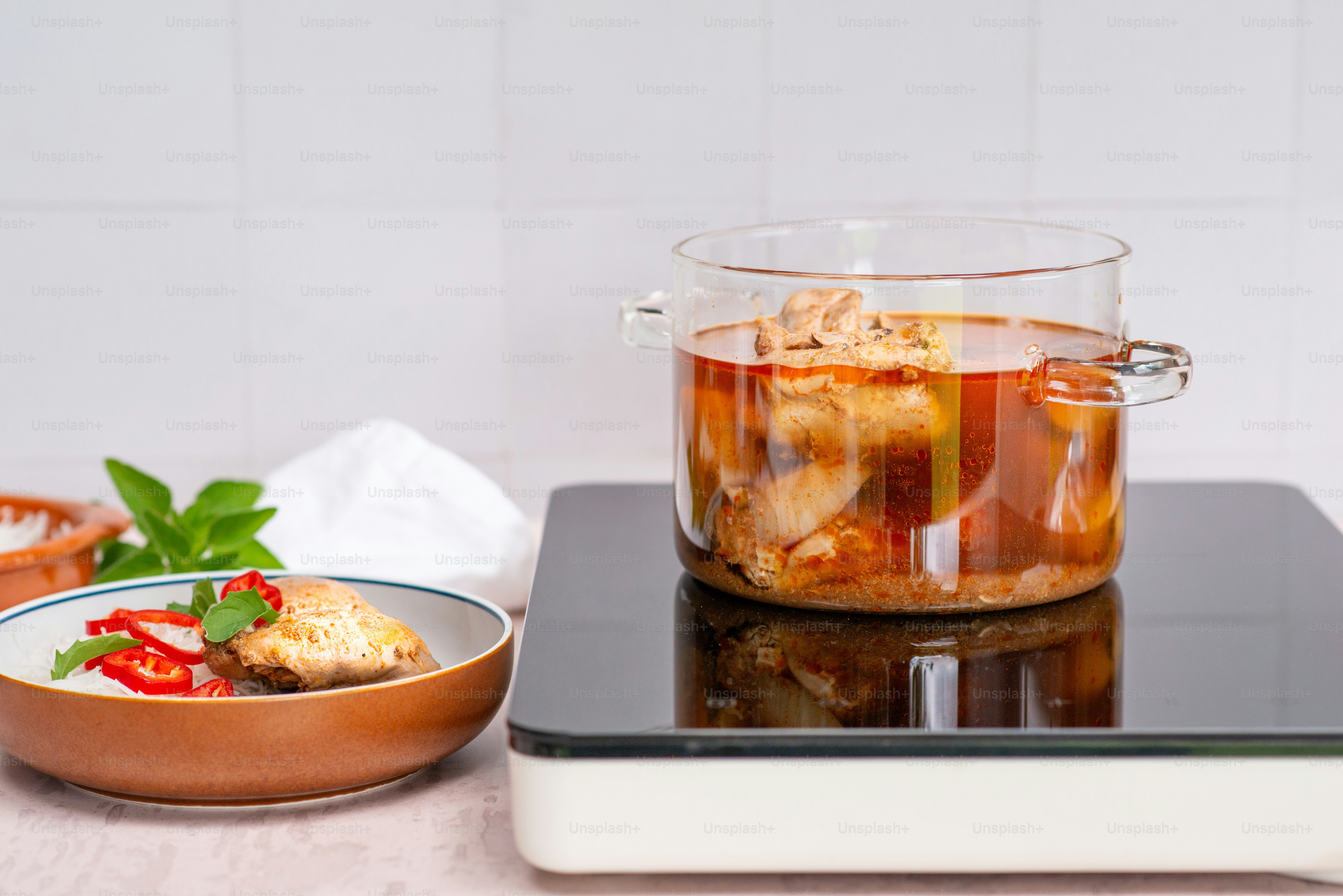 A bowl of food sitting on top of a scale photo – Induction cooktop ...