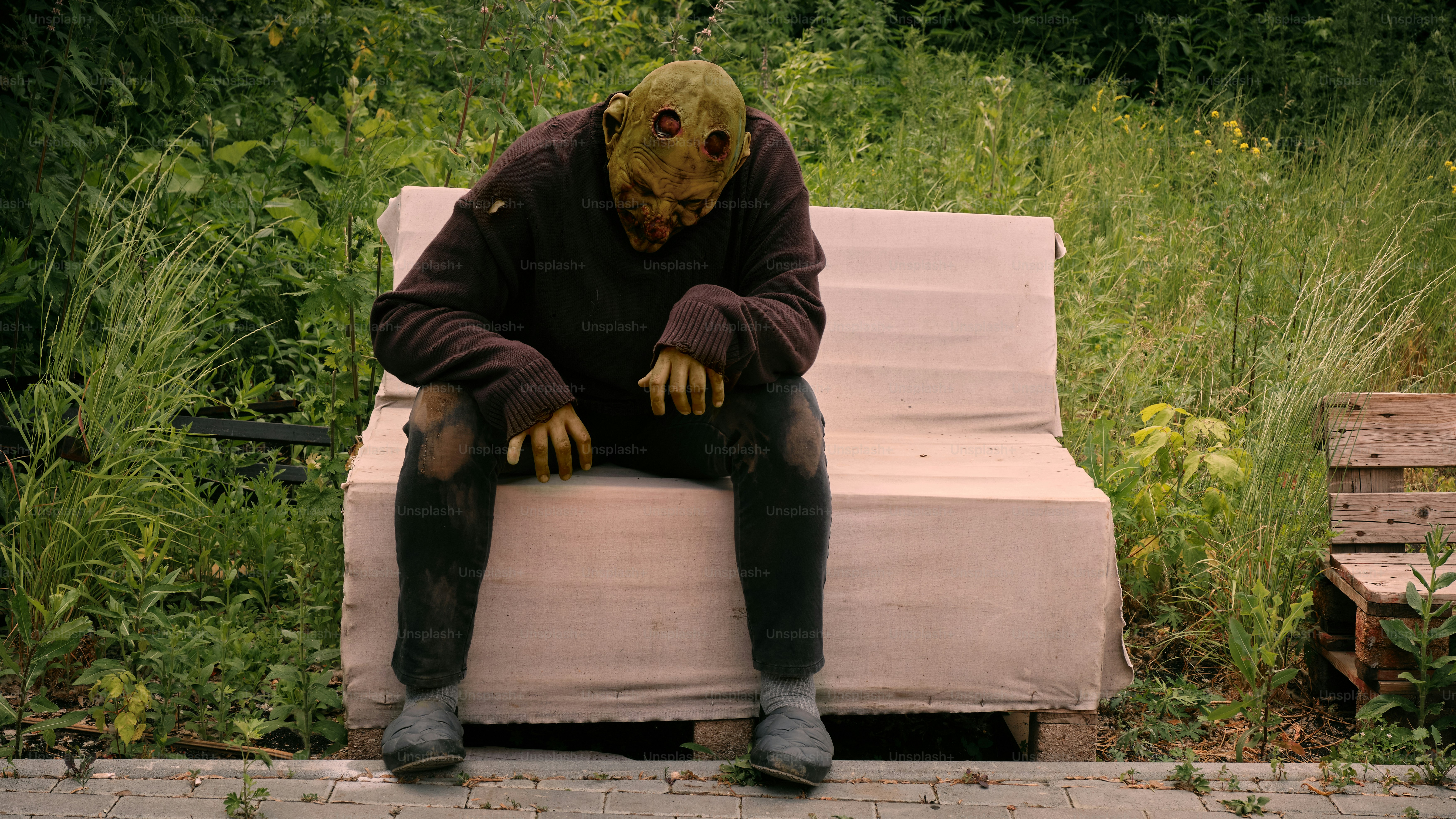 A man sitting on top of a white couch photo – Zombie apocalypse Image ...