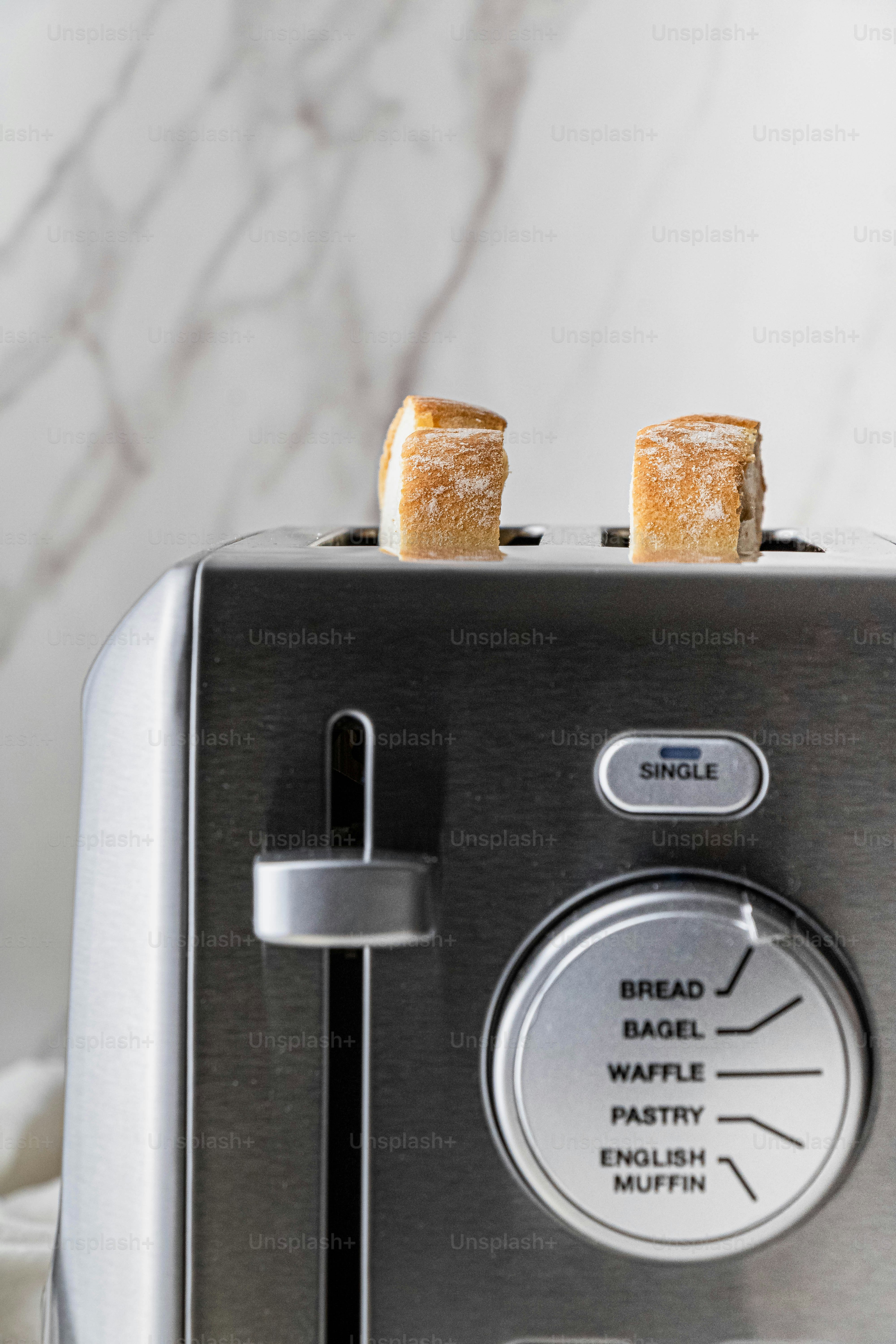 A toaster with two pieces of bread on top of it photo – Food Image on ...