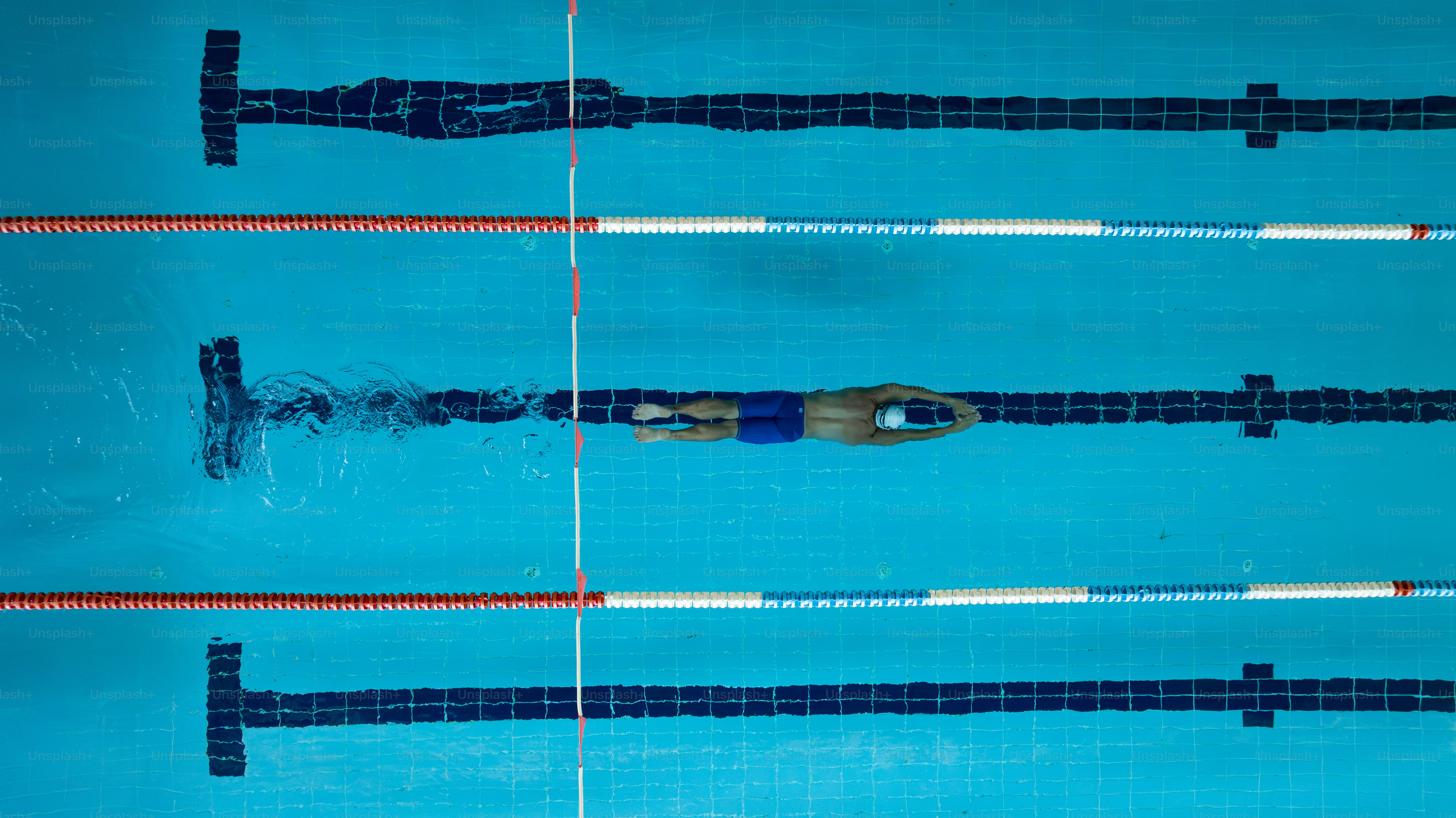 A group of swimmers in a swimming pool photo – Swimming lanes Image on ...