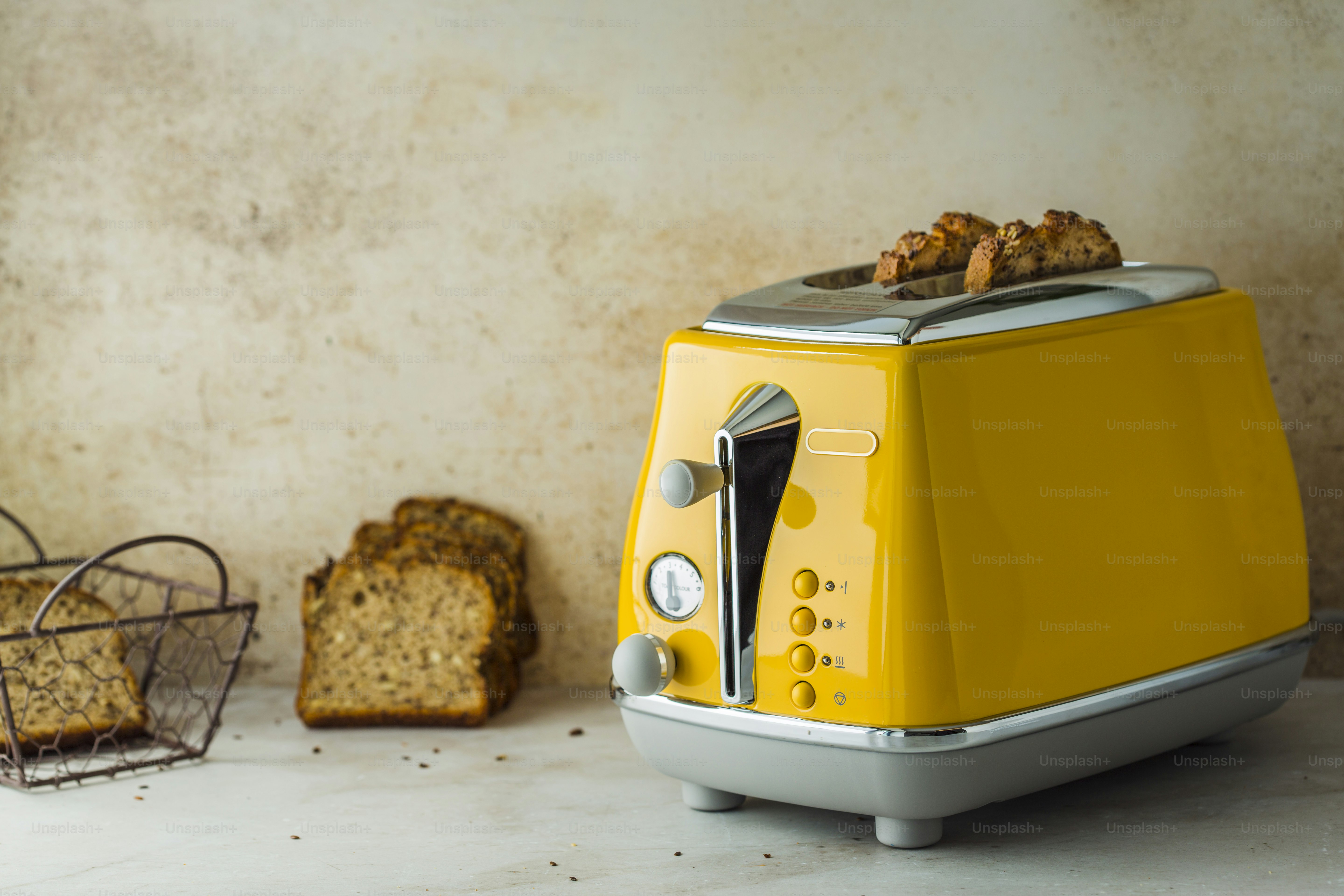 A yellow toaster sitting on top of a counter photo – Cooking with ...