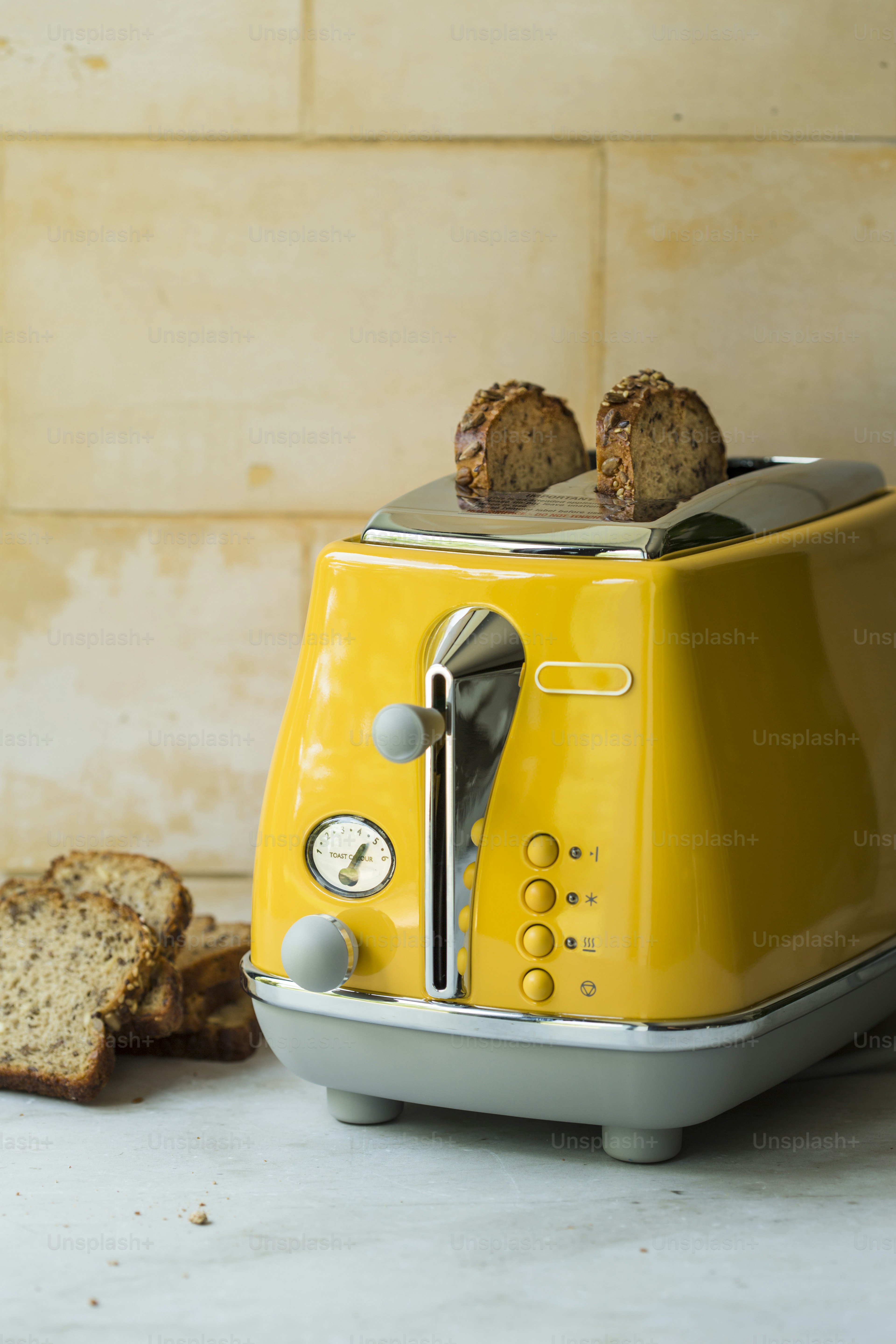 A yellow toaster sitting on top of a counter photo – Cooking with ...