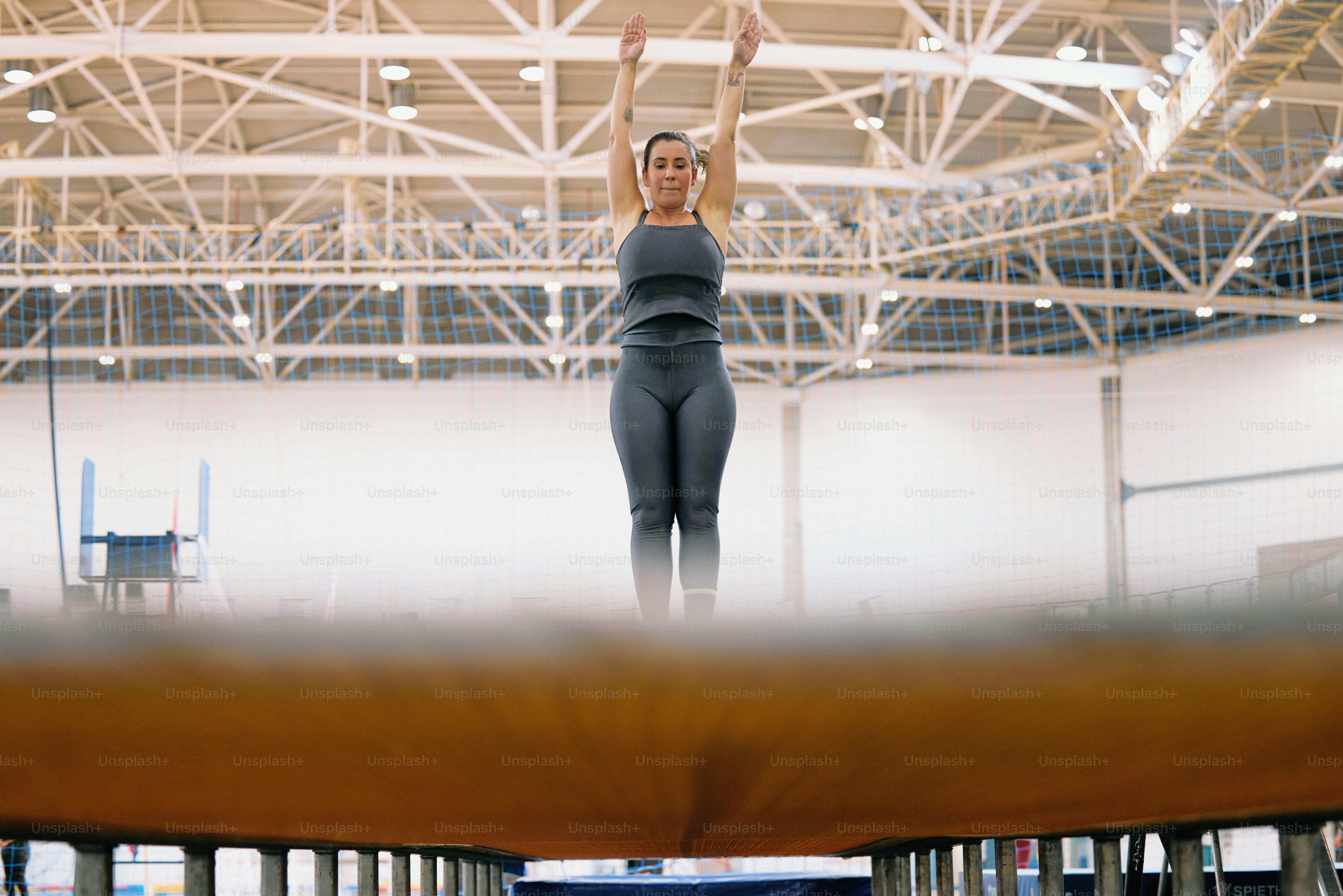 A woman standing on a beam in a gym photo – Sports Image on Unsplash