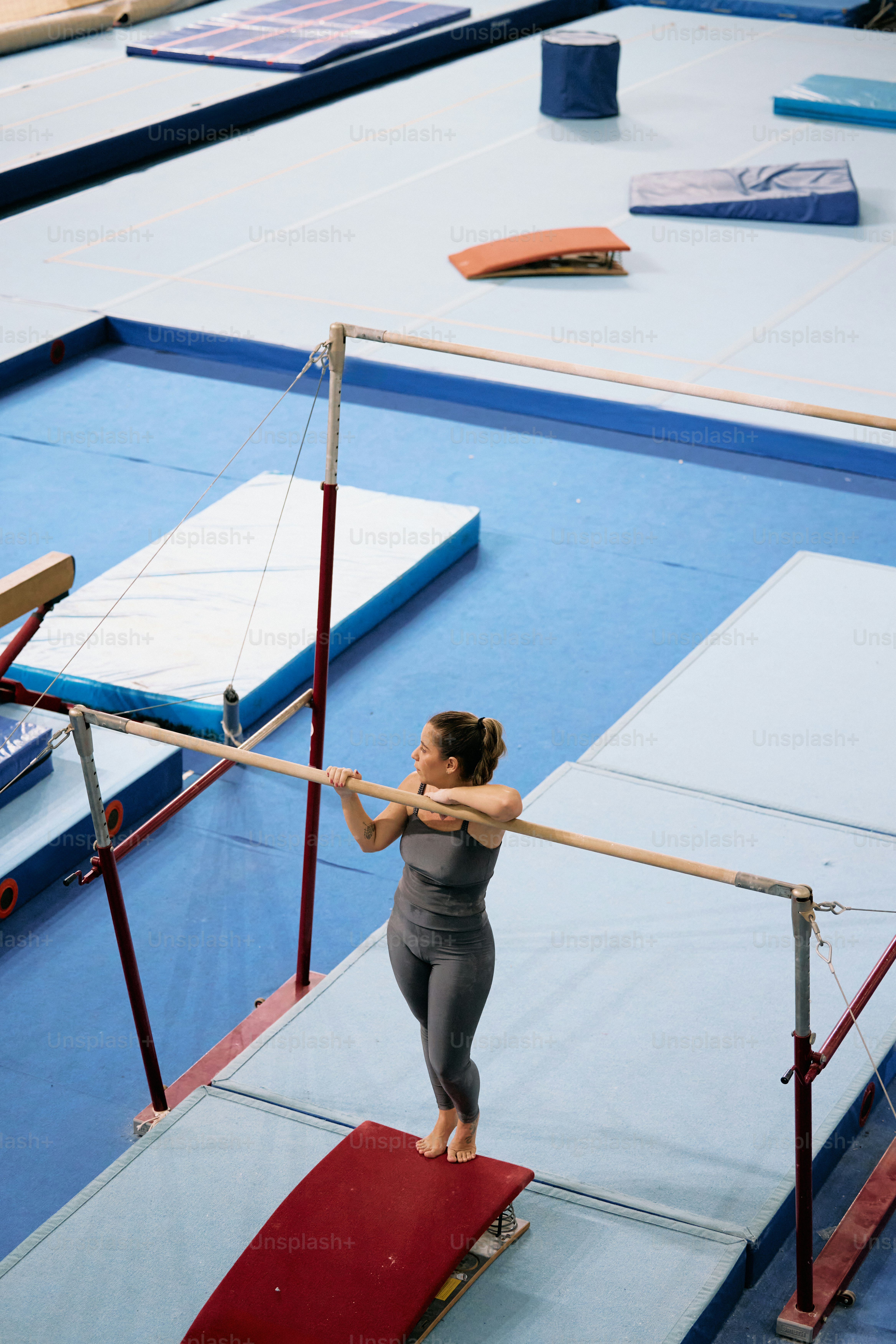 A woman on a balance beam in a gym photo – Woman Image on Unsplash