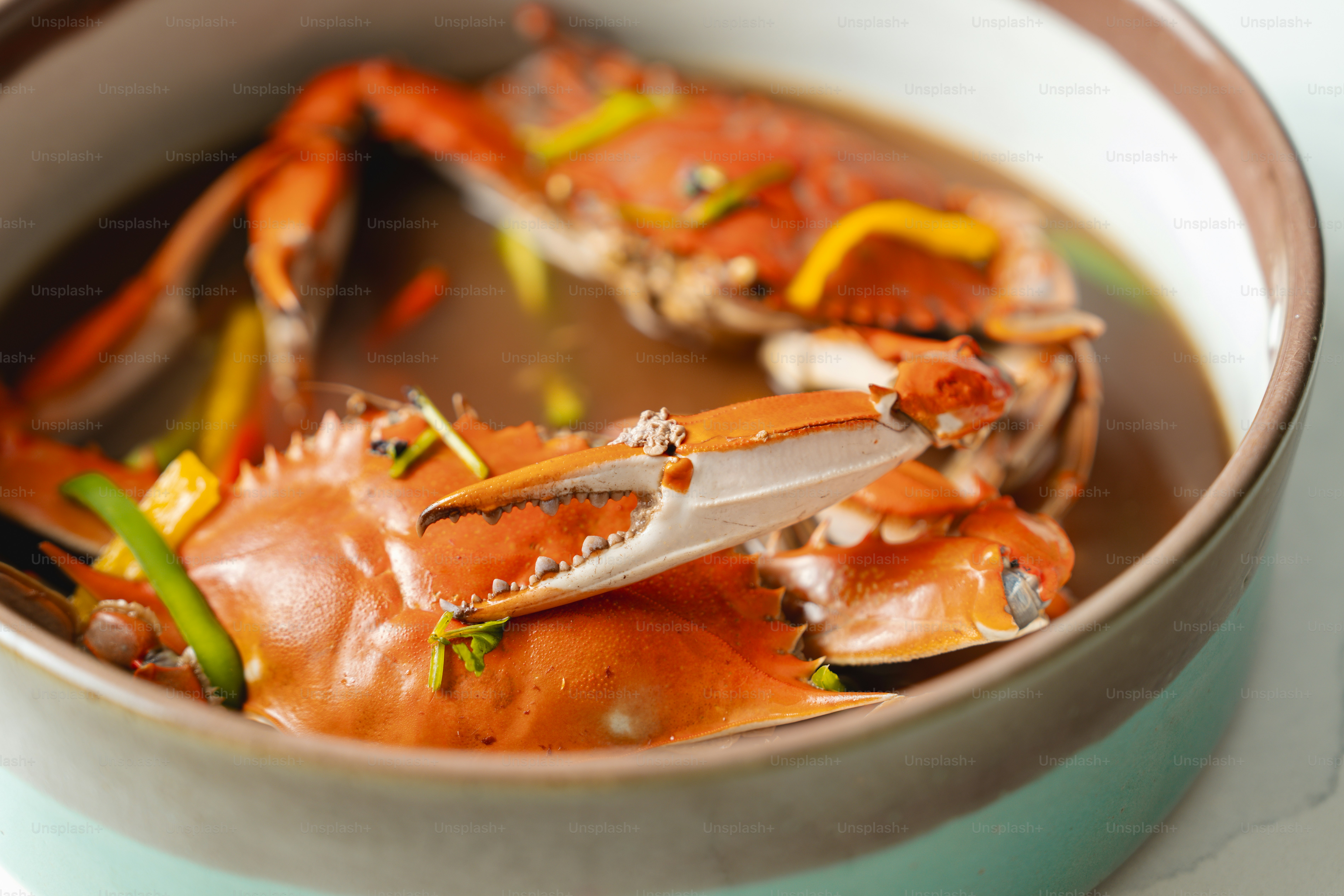 A close up of a bowl of food with crab legs photo – Seafood Image on ...