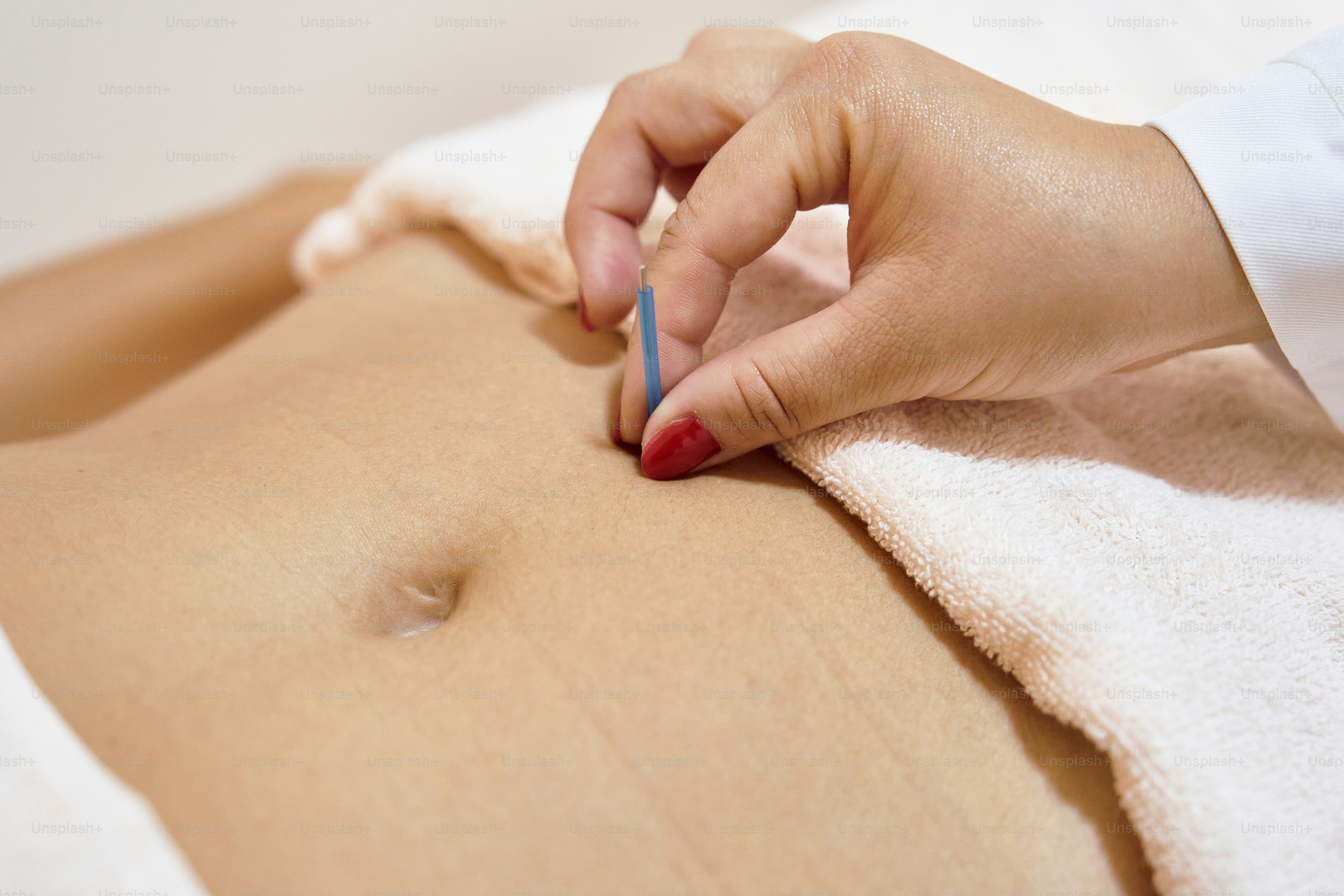 A woman getting her stomach examined by a doctor photo – Chinese ...
