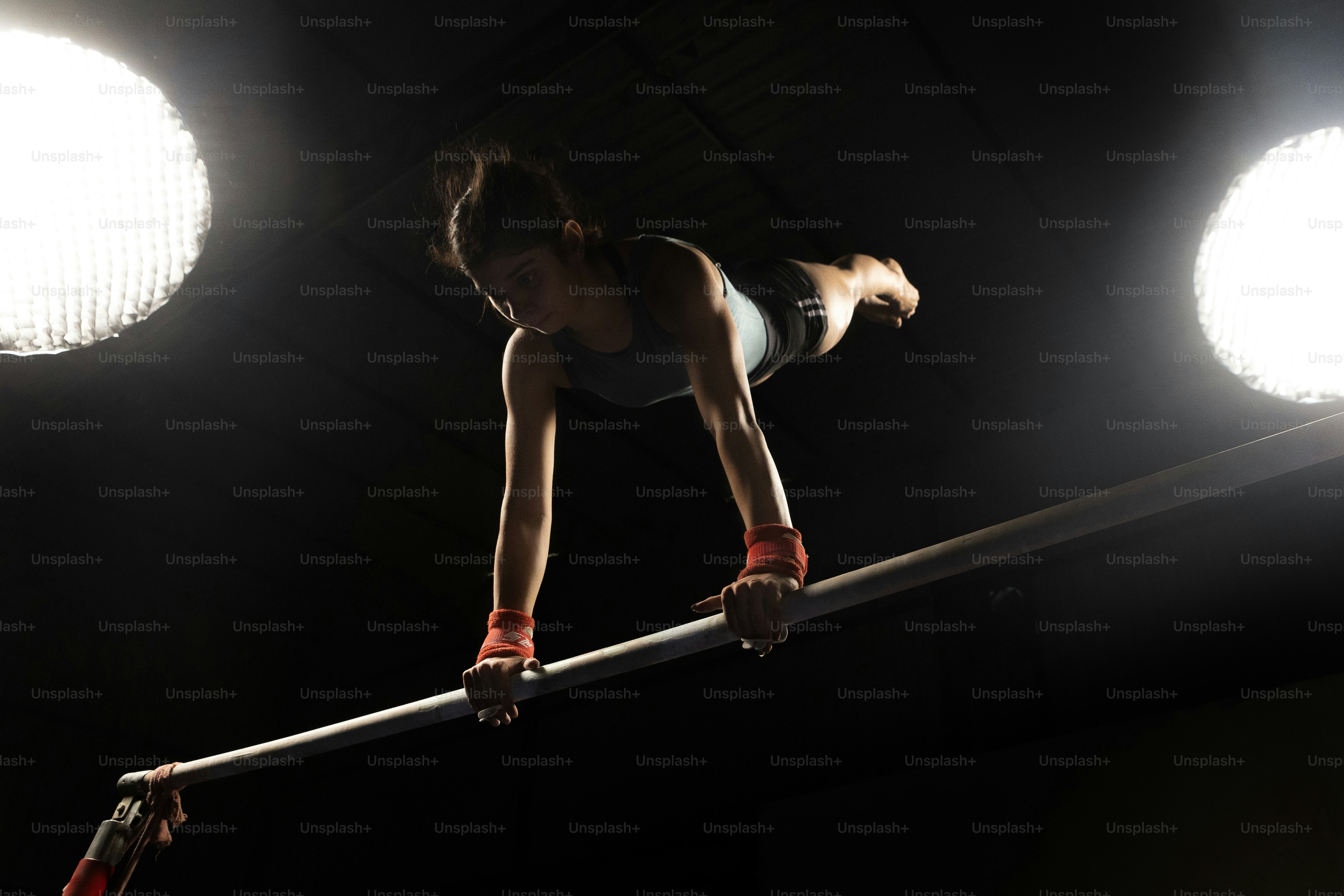 A person on a balance beam in the dark photo – Gymnast Image on Unsplash