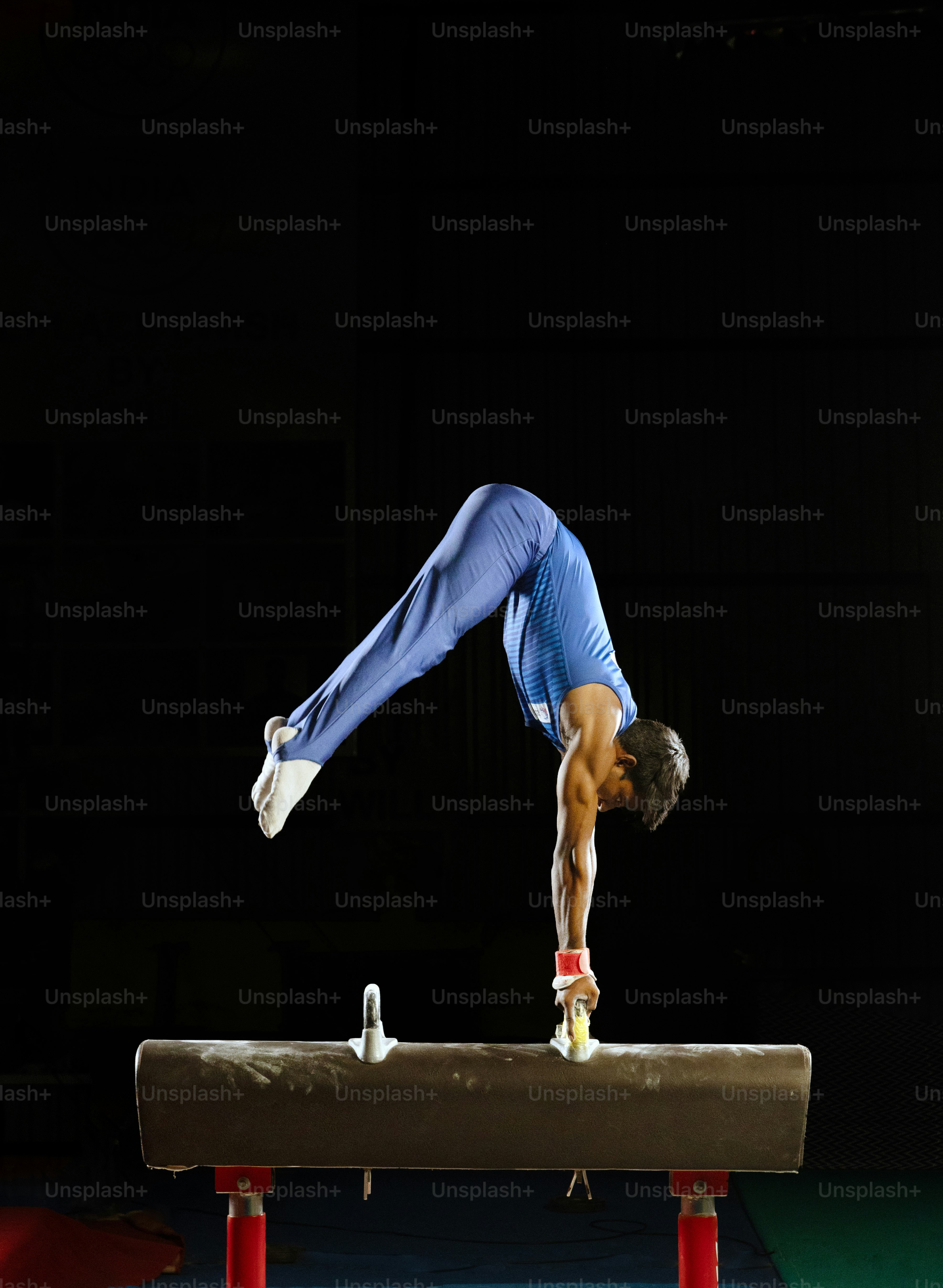 A woman doing a handstand on a balance beam photo – Olympic sport Image ...