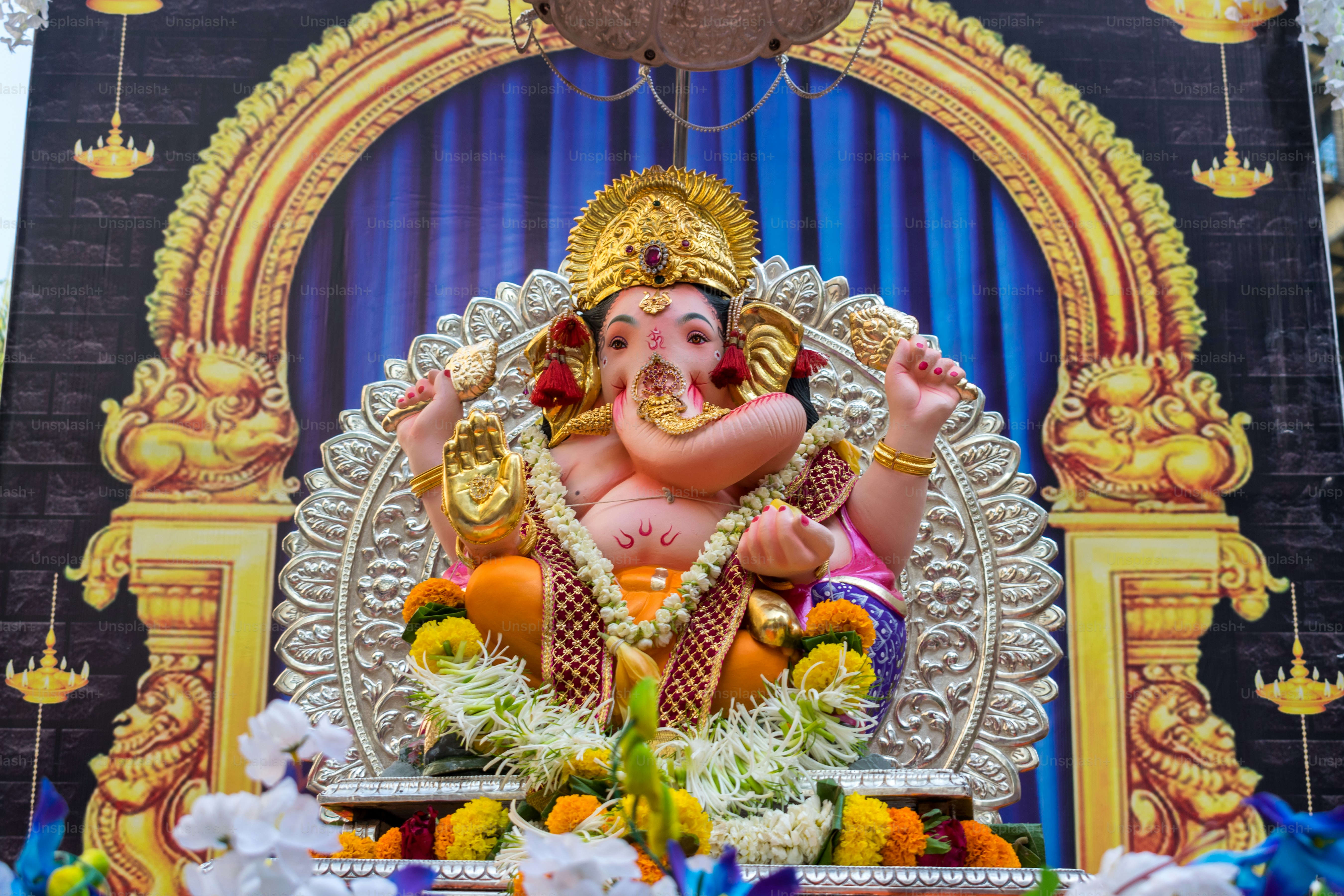 A statue of a god in front of a building photo – Celebration Image on ...