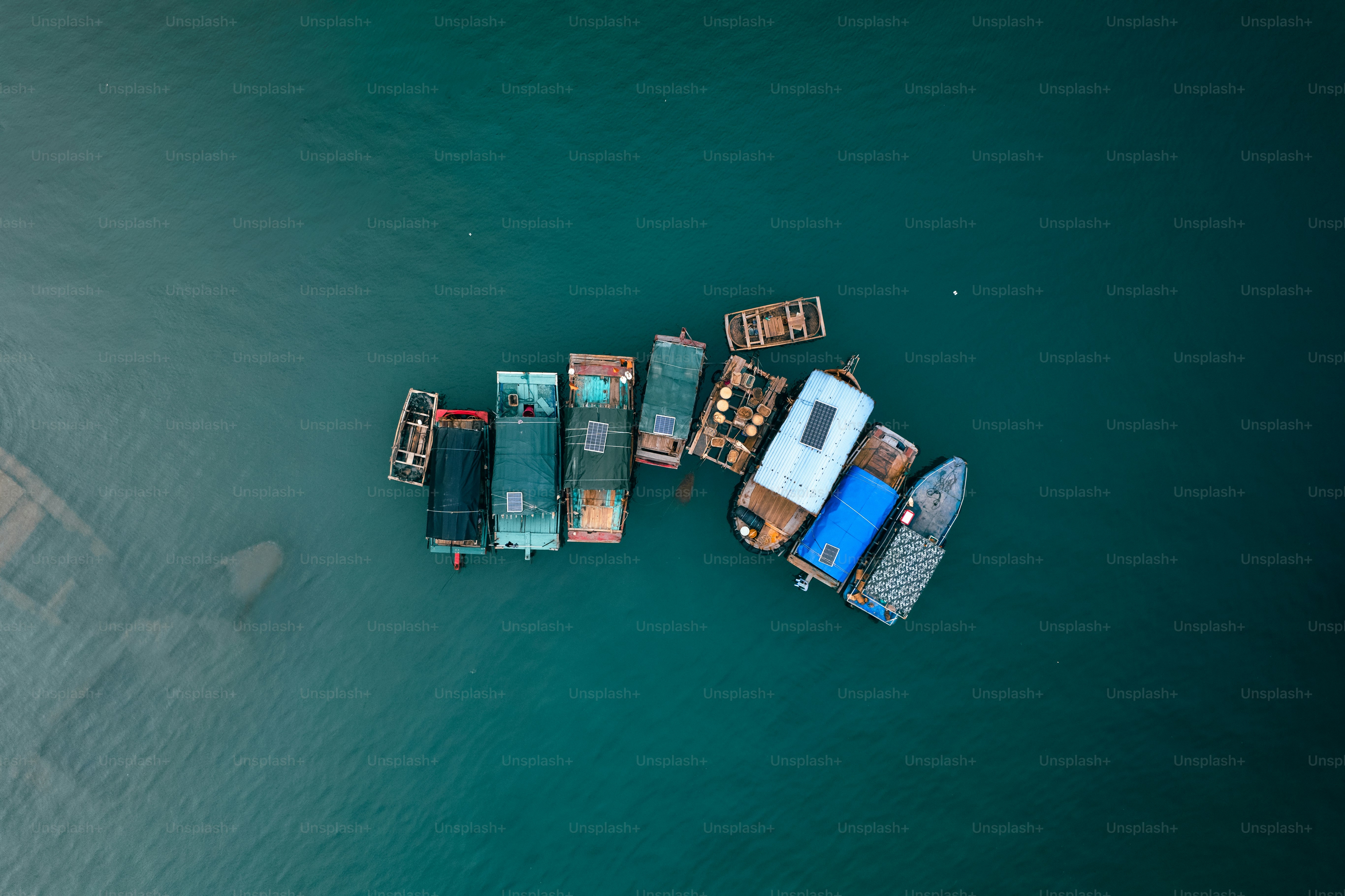 A group of boats floating on top of a body of water photo – Vietnam ...
