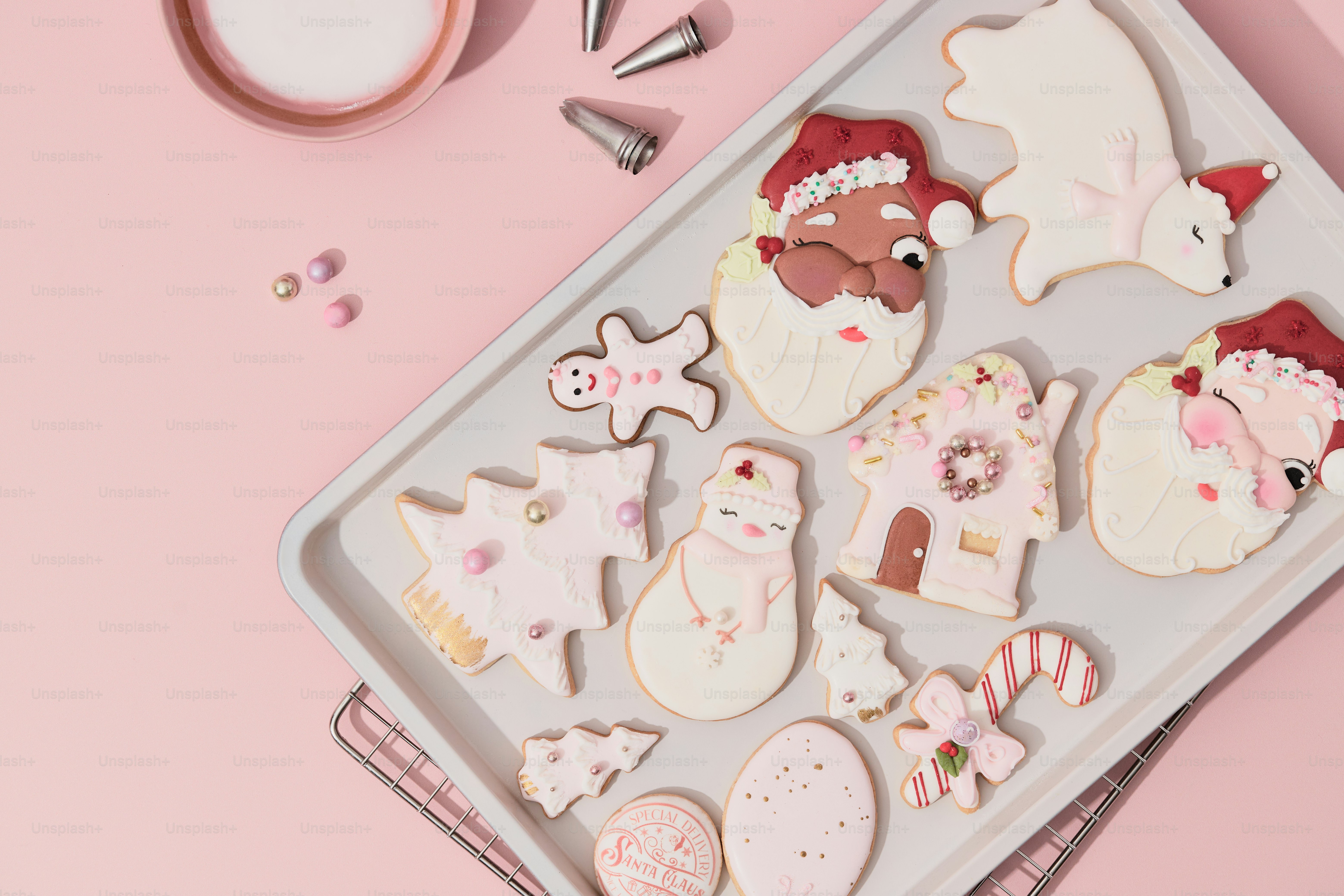 A tray of decorated cookies next to a pair of scissors photo ...